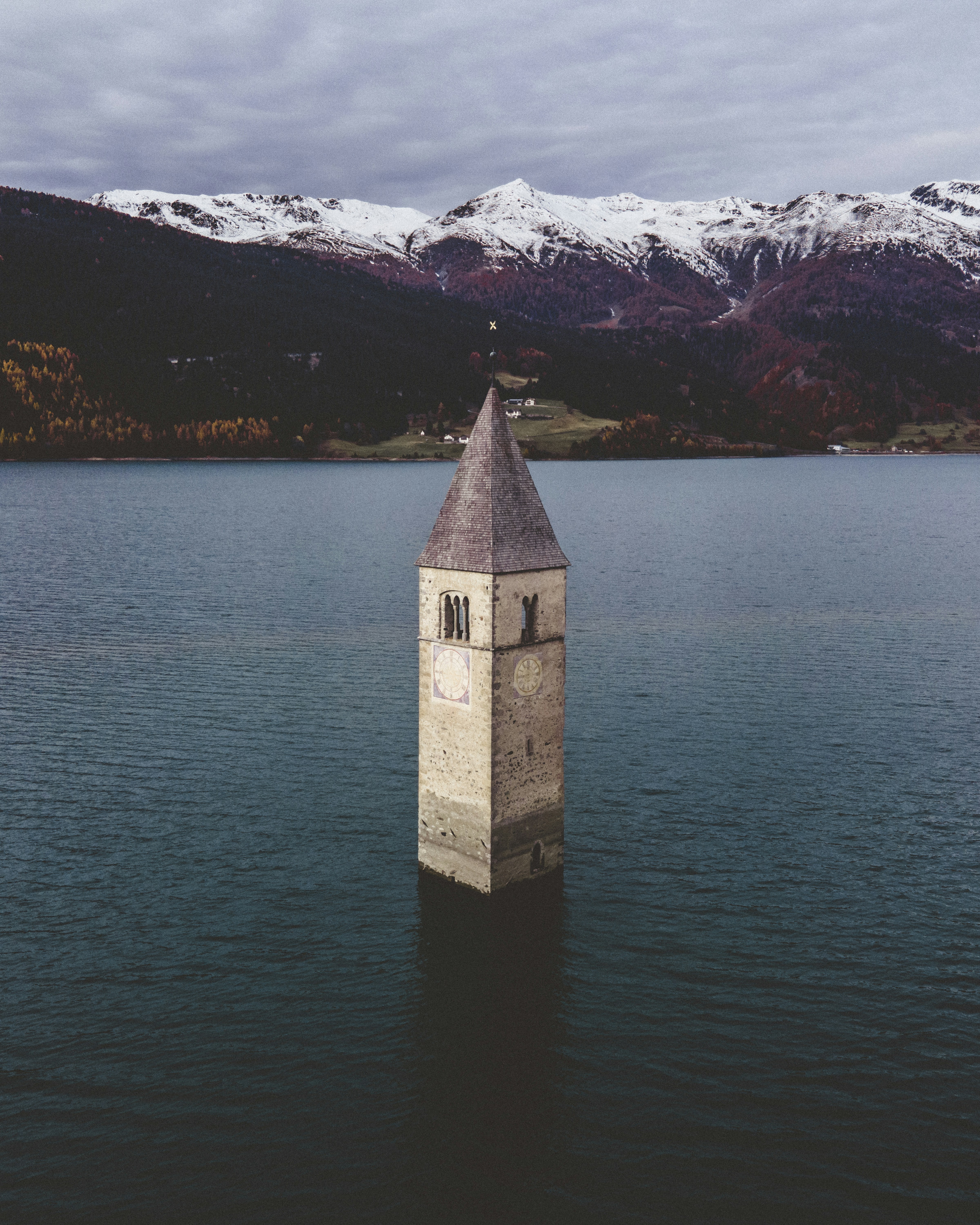 A Lone Stone Spire Rising from Alpine Lake