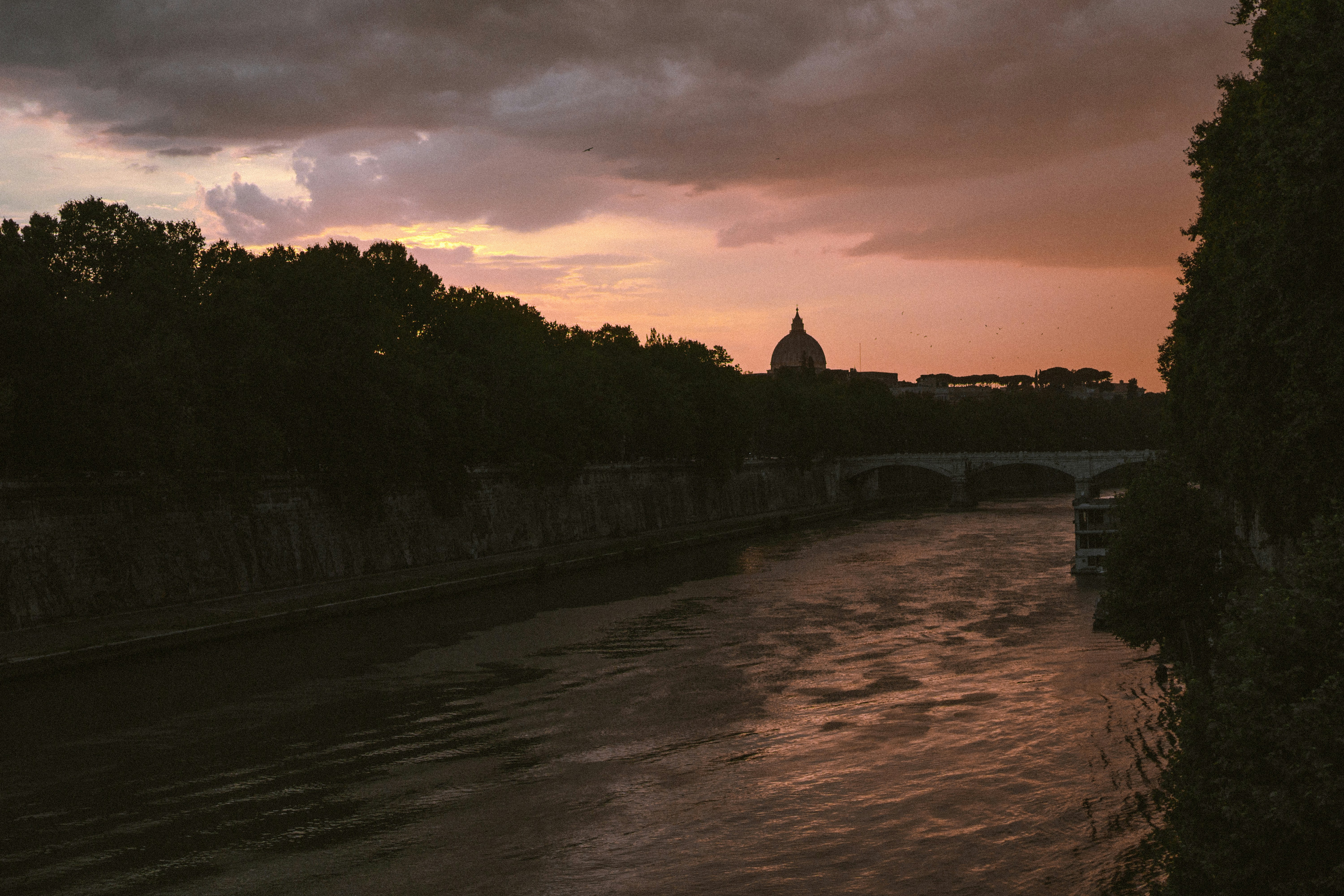 Dome Against the Dusk: Silhouetted Skyline Over a Quiet River
