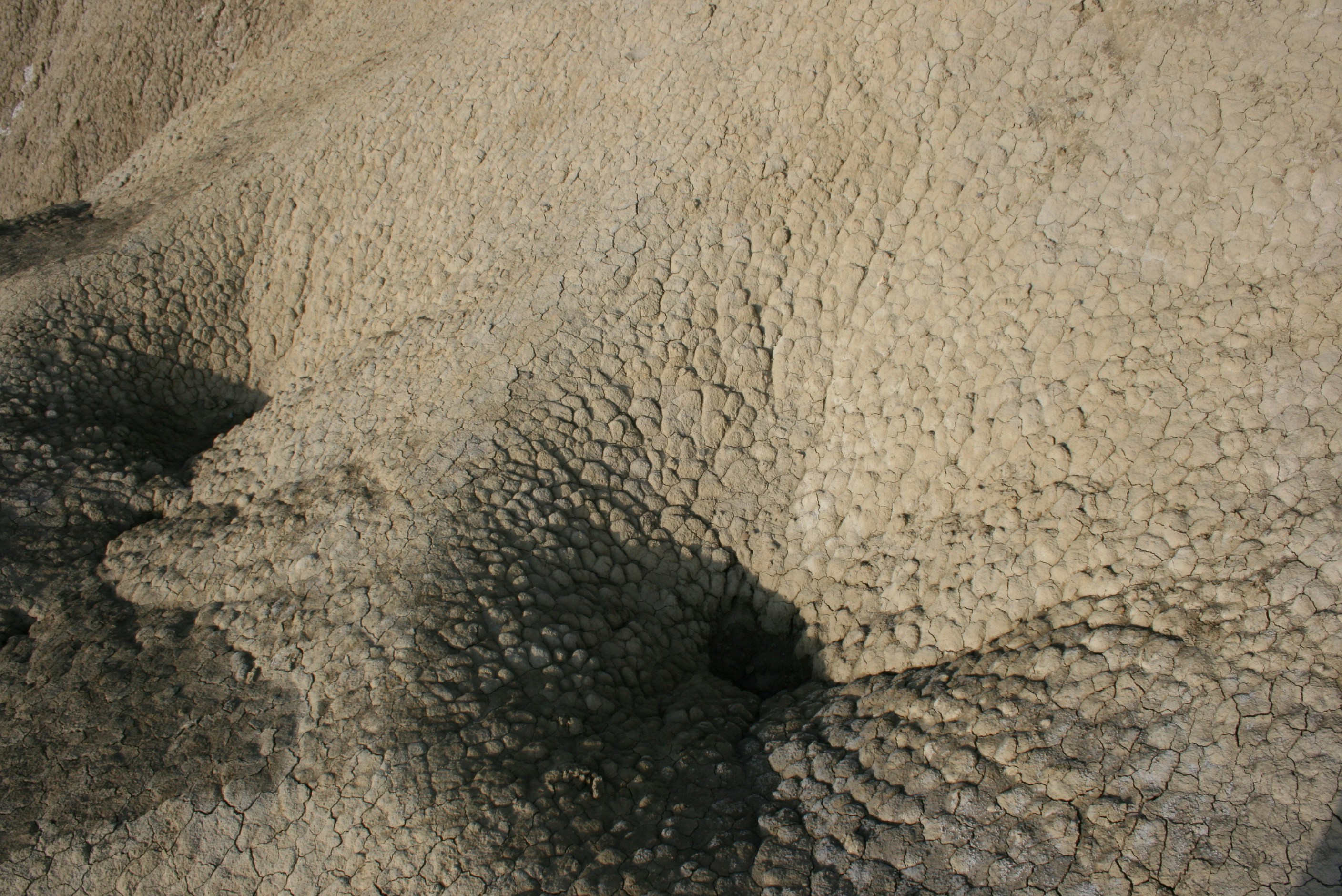 Hollow in the Hex: Close-Up of Cracked Lava Crust
