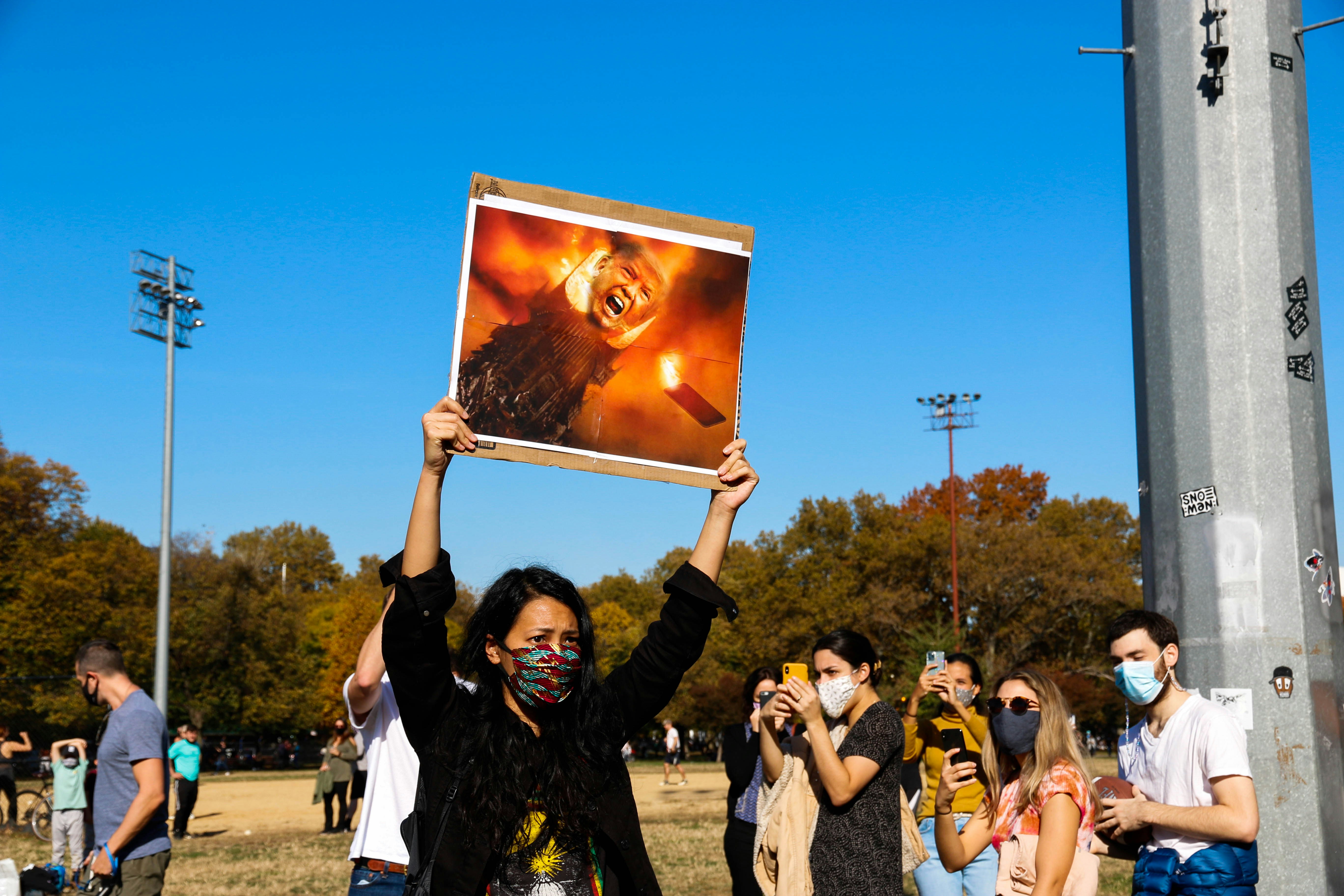 people in black and yellow dress holding fire