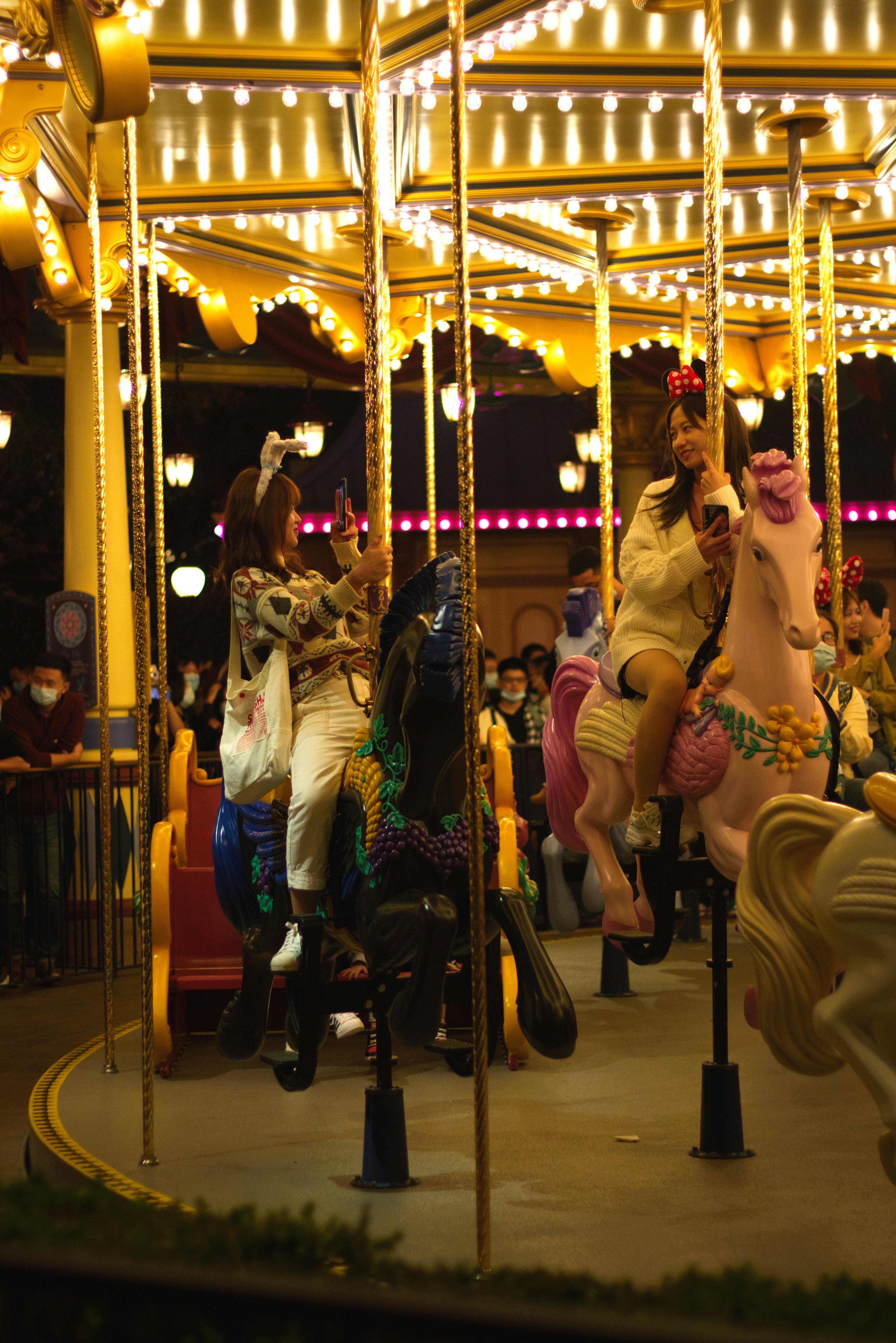 A group of people riding on a merry go round photo – Free Shanghai ...