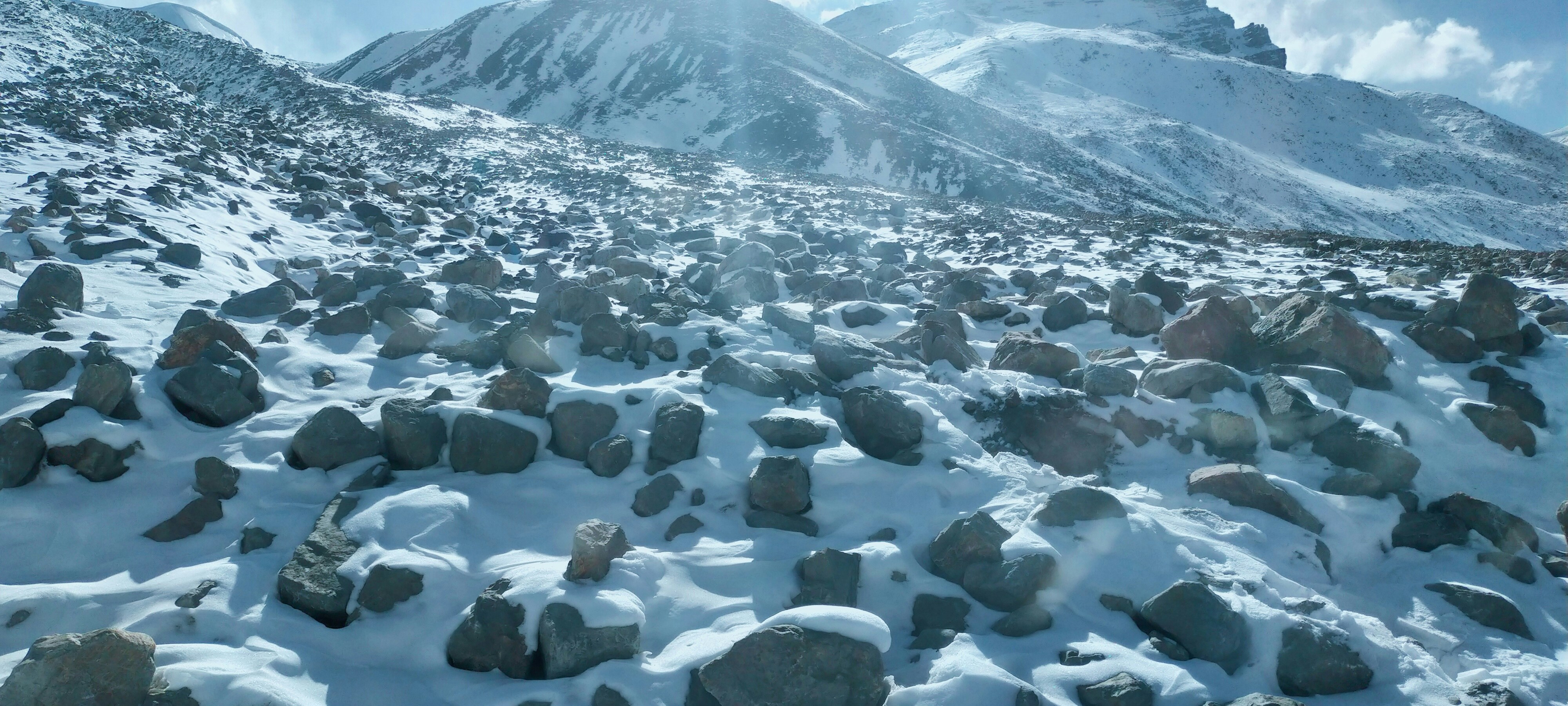 rocky mountain covered with snow during daytime