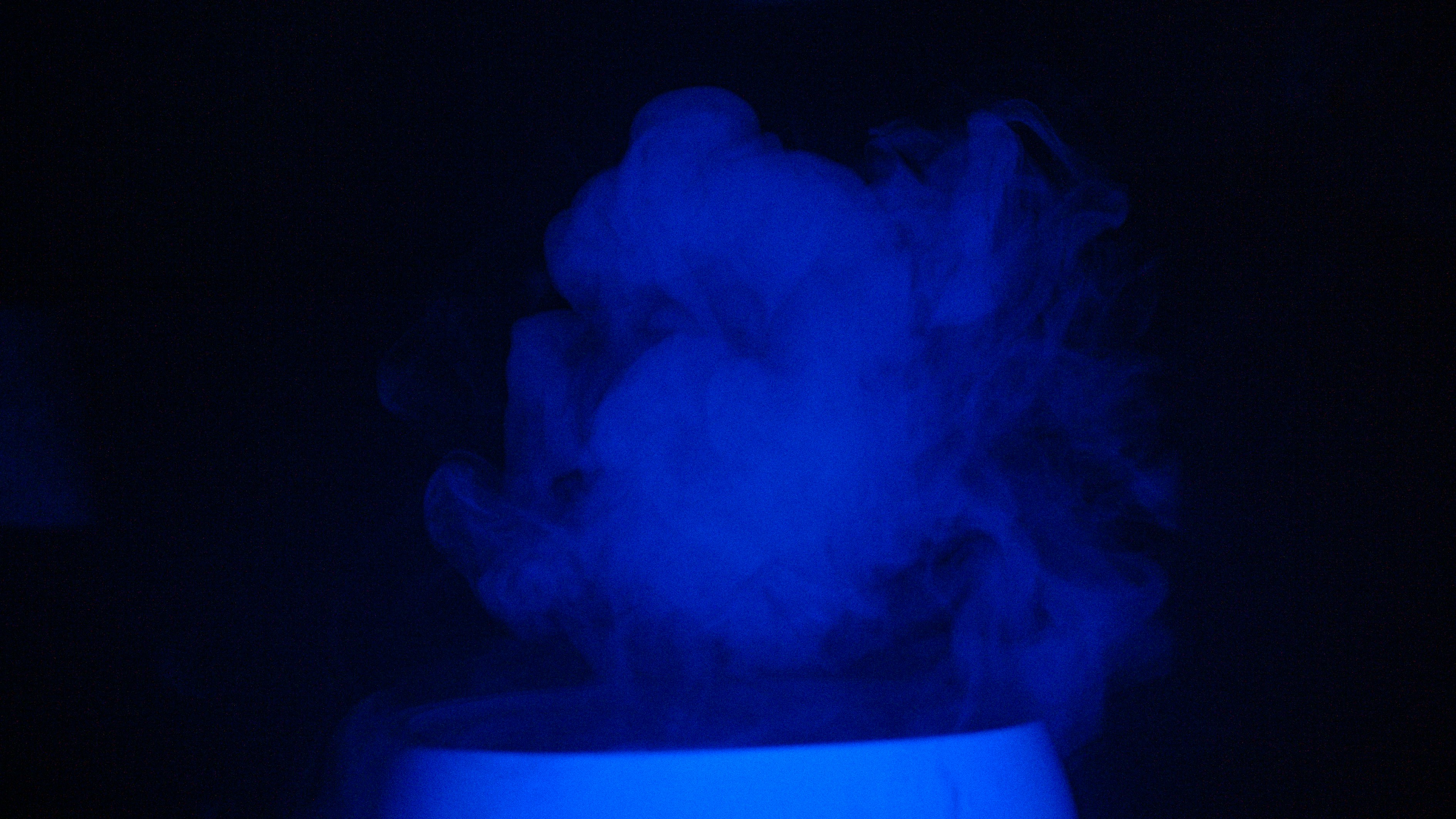 Blue Plume Rising from a Dark Vessel in a Velvet Night