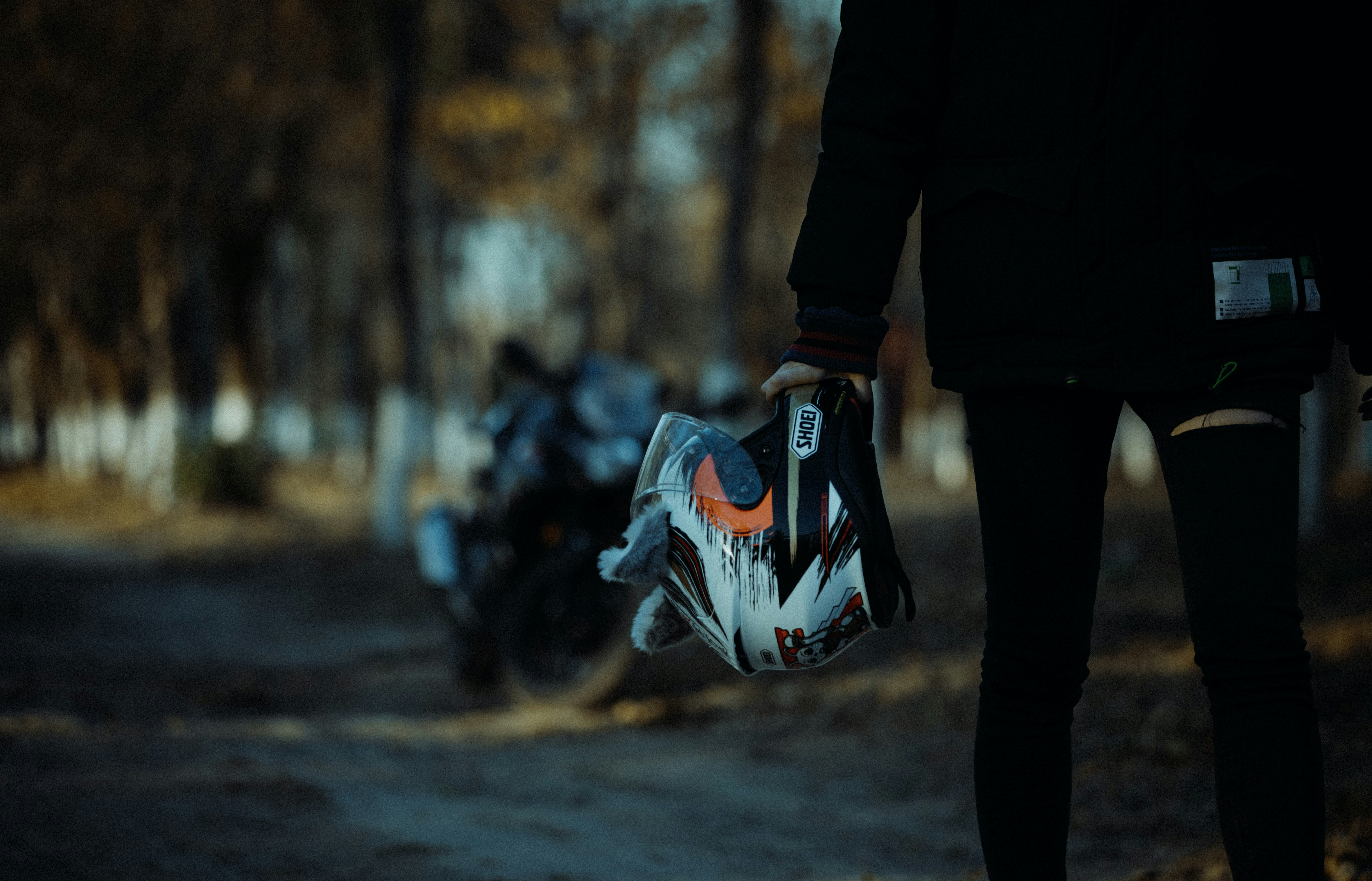 Helmet in Hand on a Quiet Autumn Path