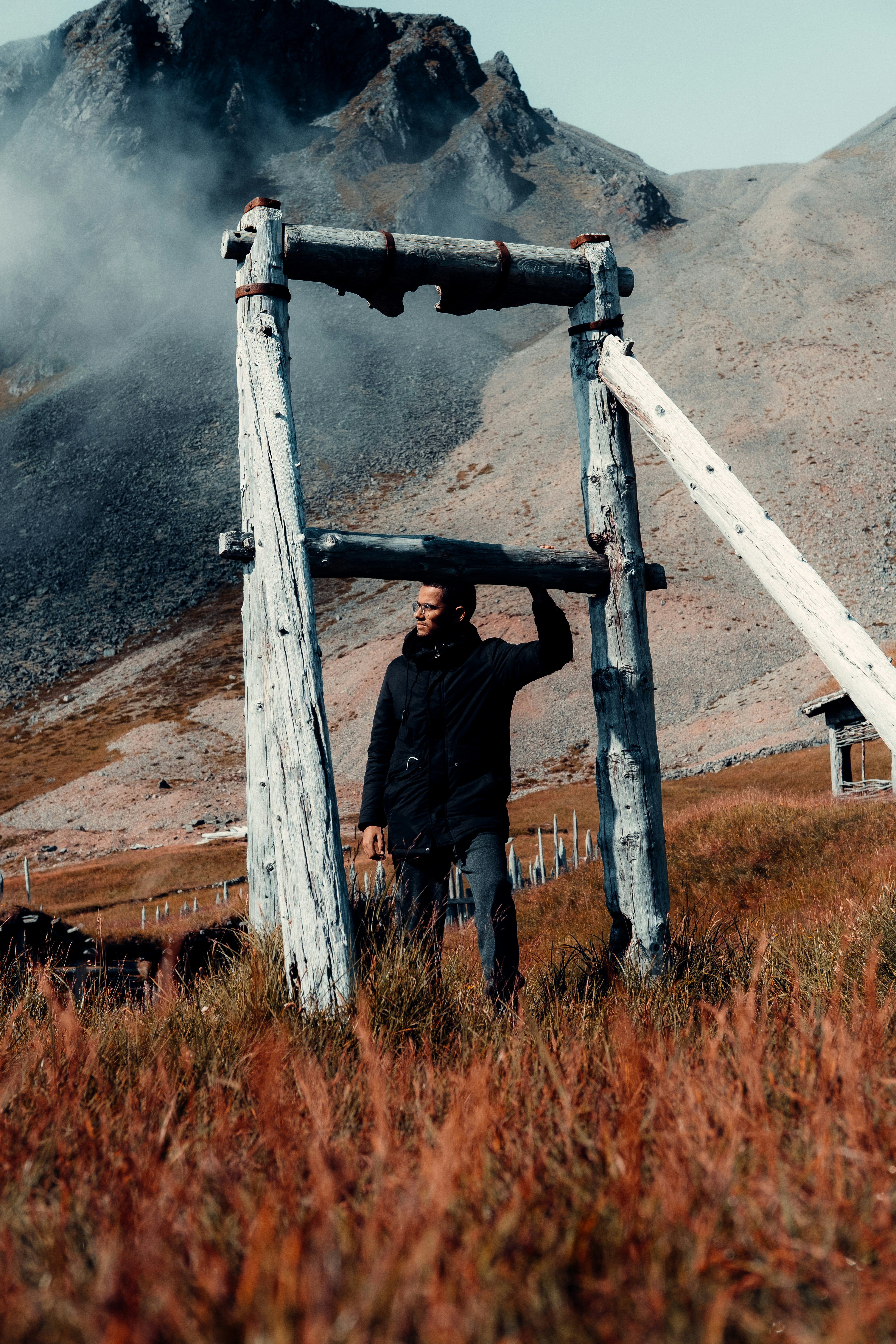 Man in black jacket standing on brown wooden ladder photo – Free ...