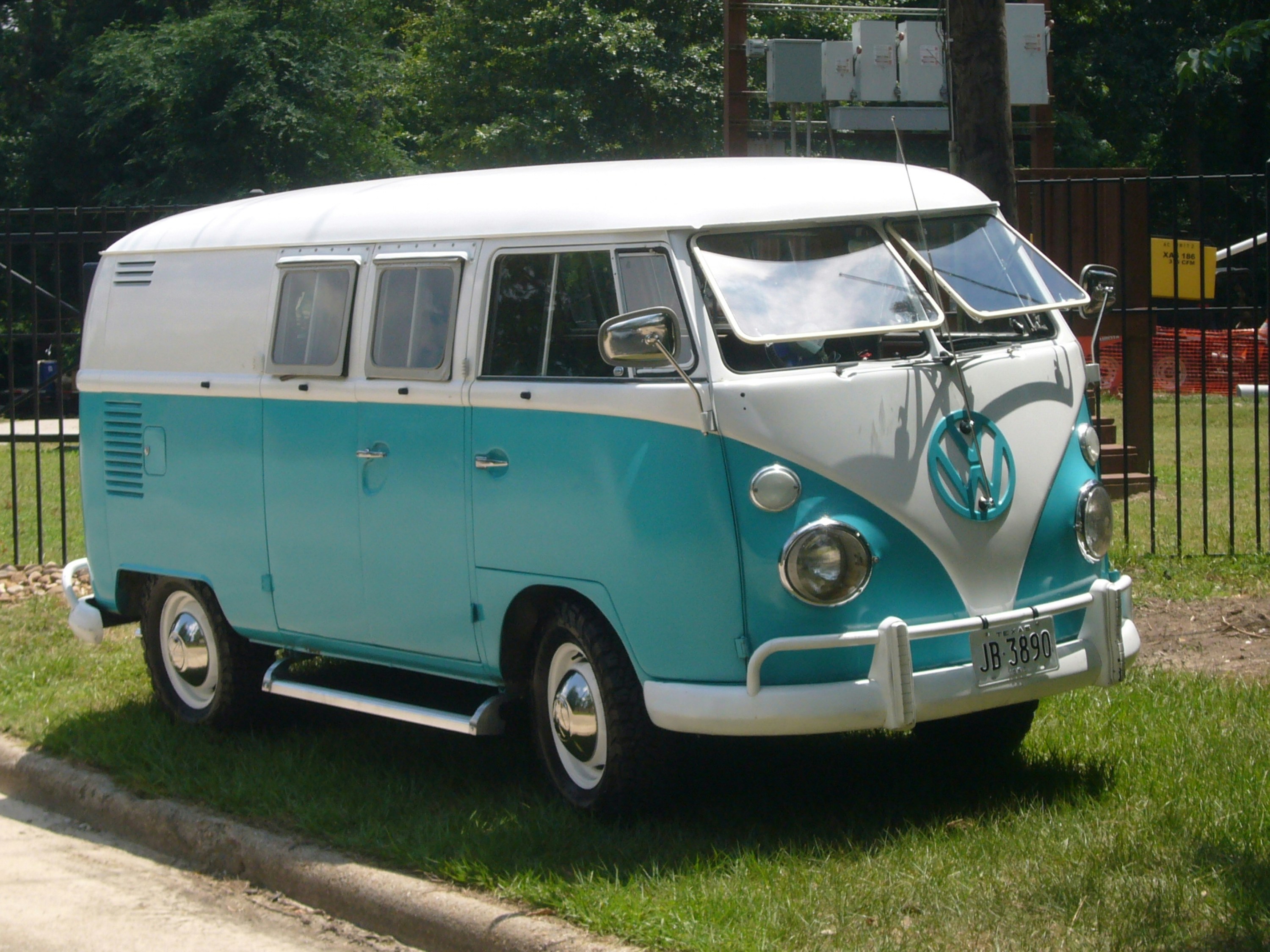 Blue and white volkswagen t-2 van parked on the side of the road during ...