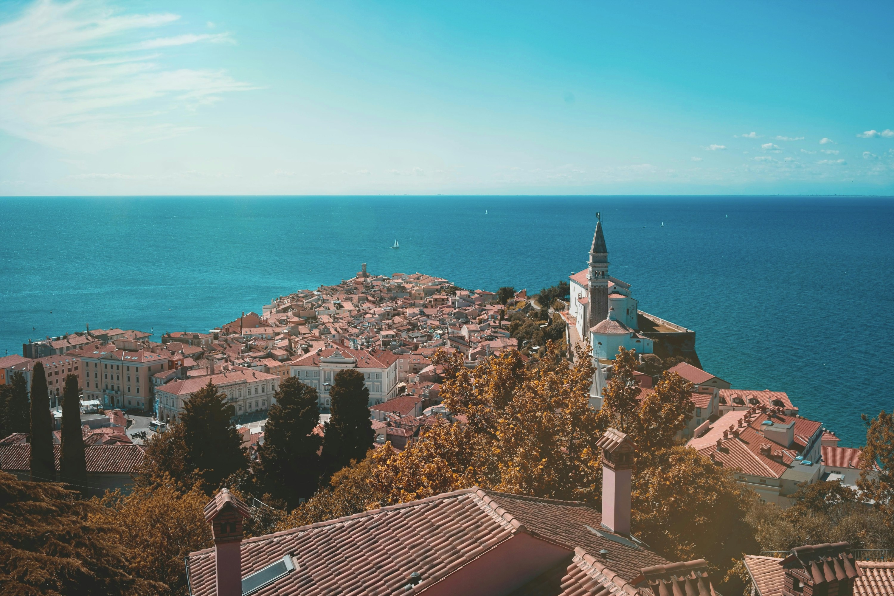 Coastal Village Rising from Terracotta Rooftops toward a Sapphire Sea