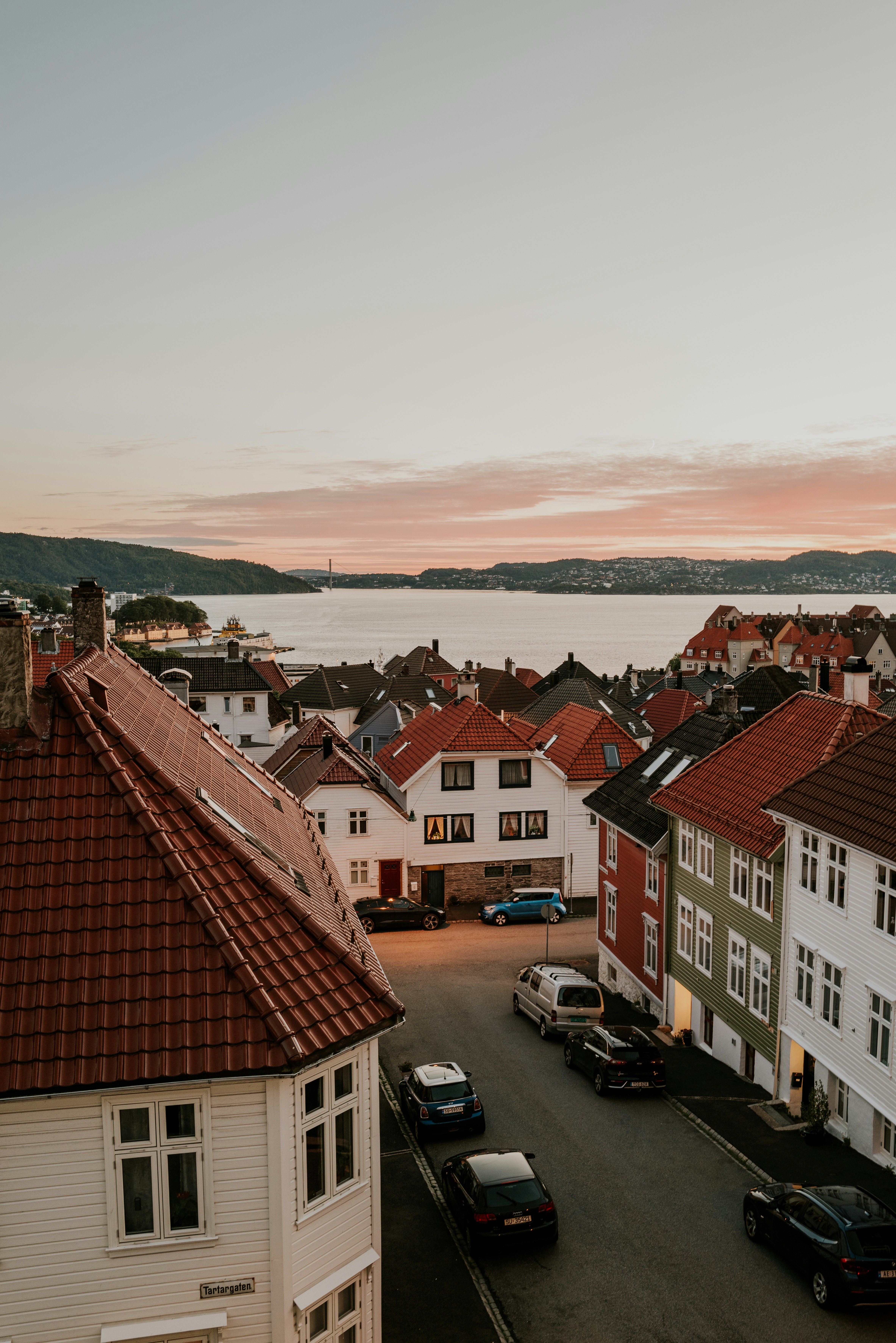 Nice view from my friends apartment in Bergen. | cars parked on parking lot near houses during daytime