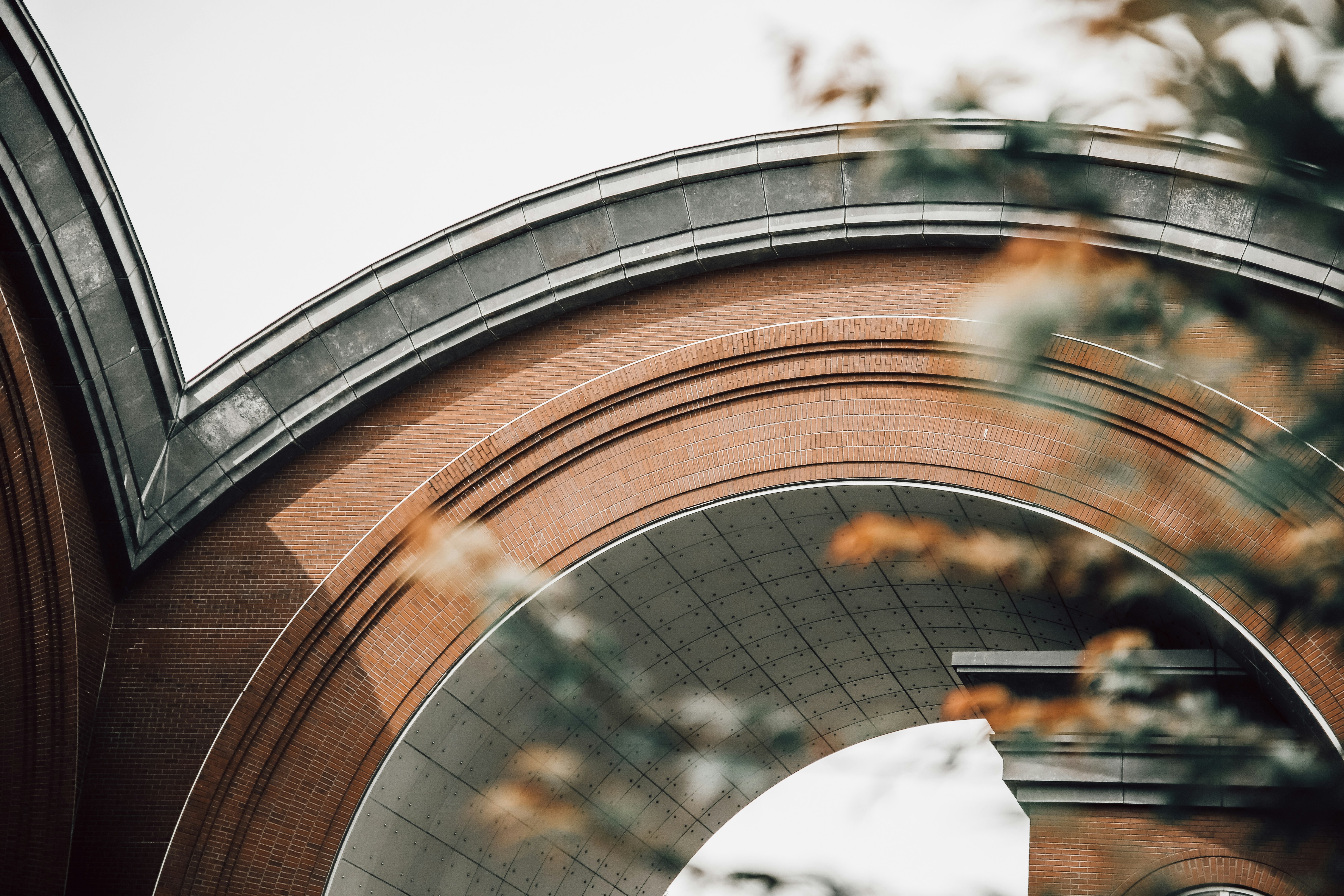 Concentric Brick Arch: A Circular Frame Amid Soft Foliage