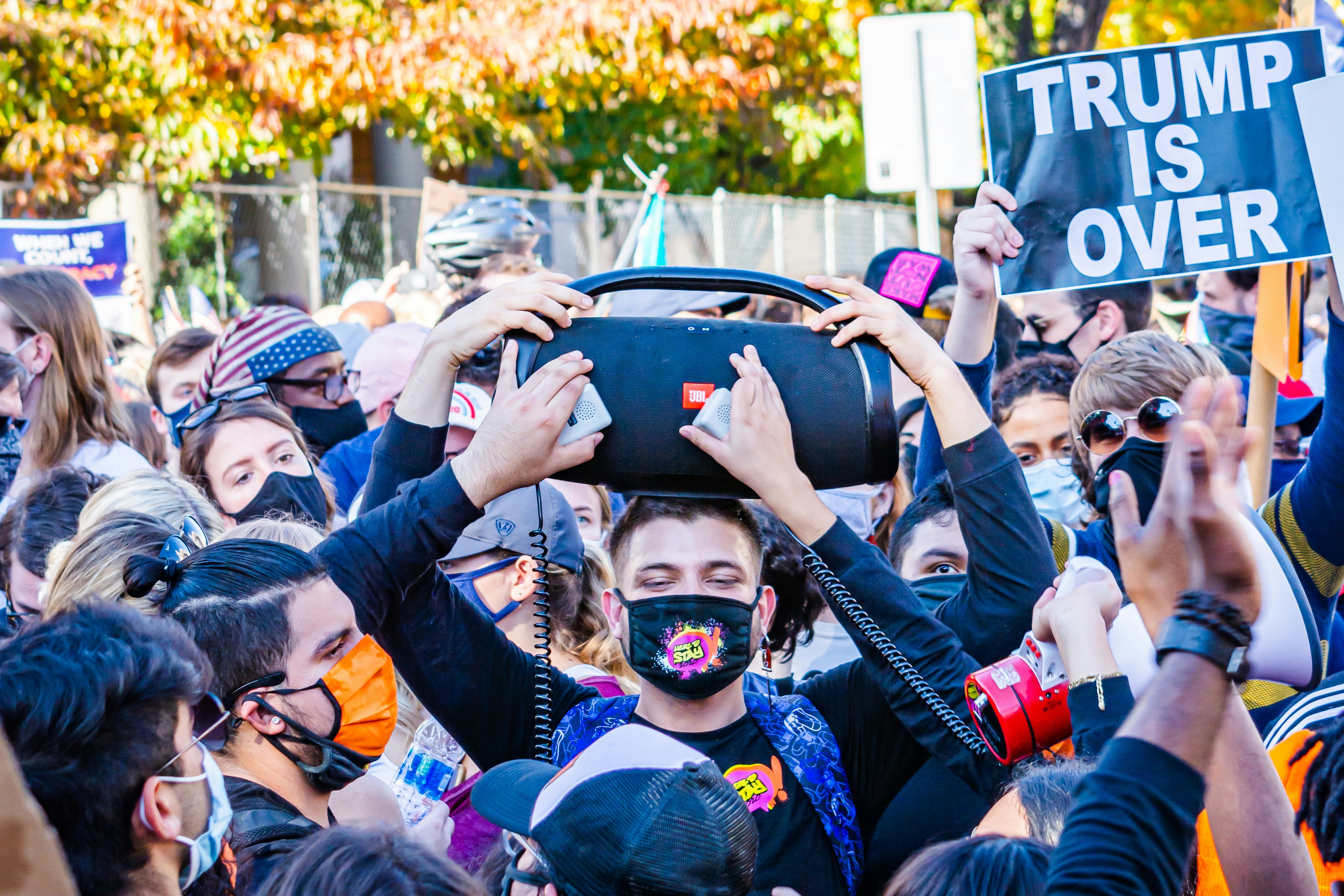 Crowd of protesters gathered, holding signs and expressing their views with passion and energy.