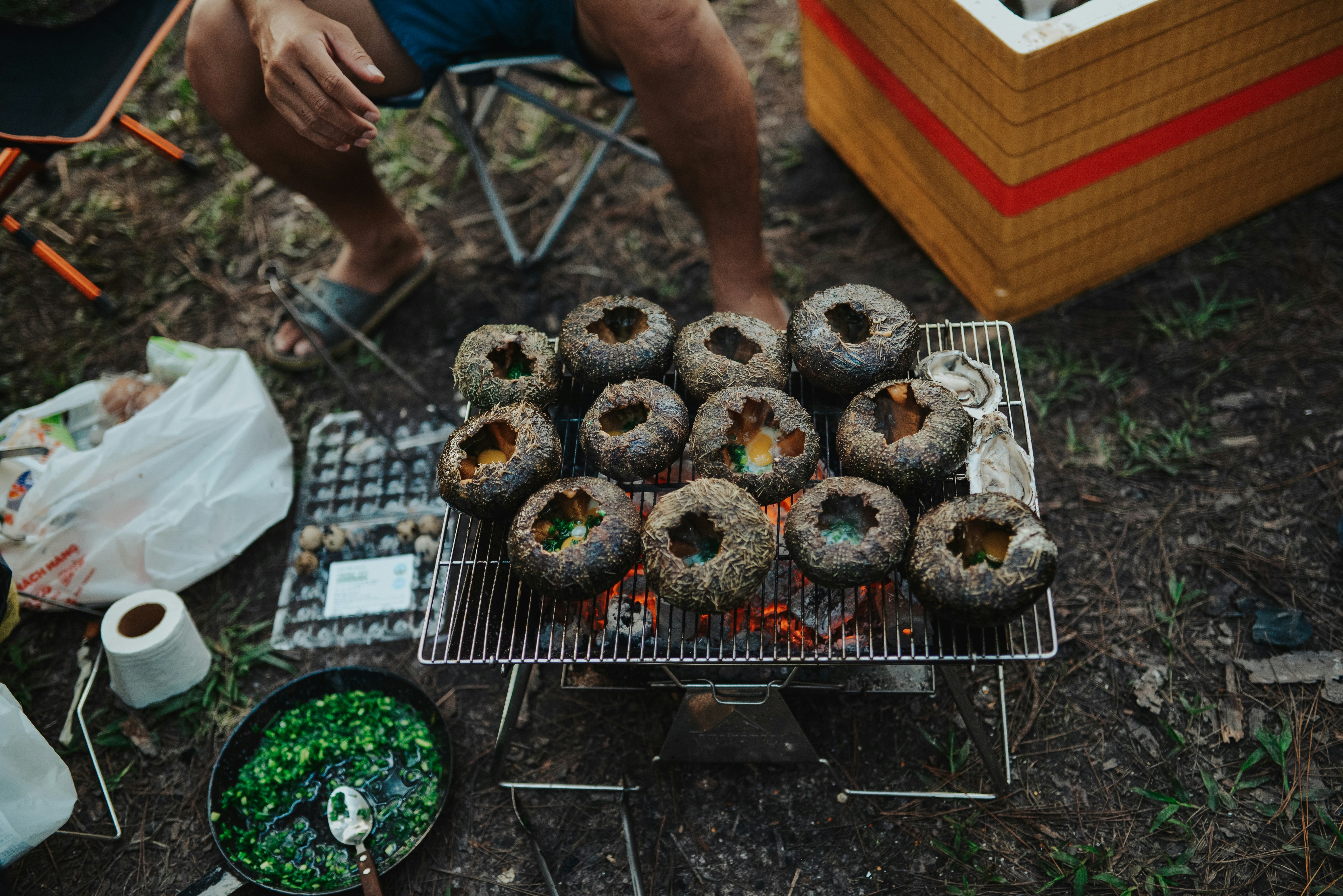 Charcoal Ring Delights: Colorful Fillings Peek Through Hollow Donuts Grilling on a Backyard Grill