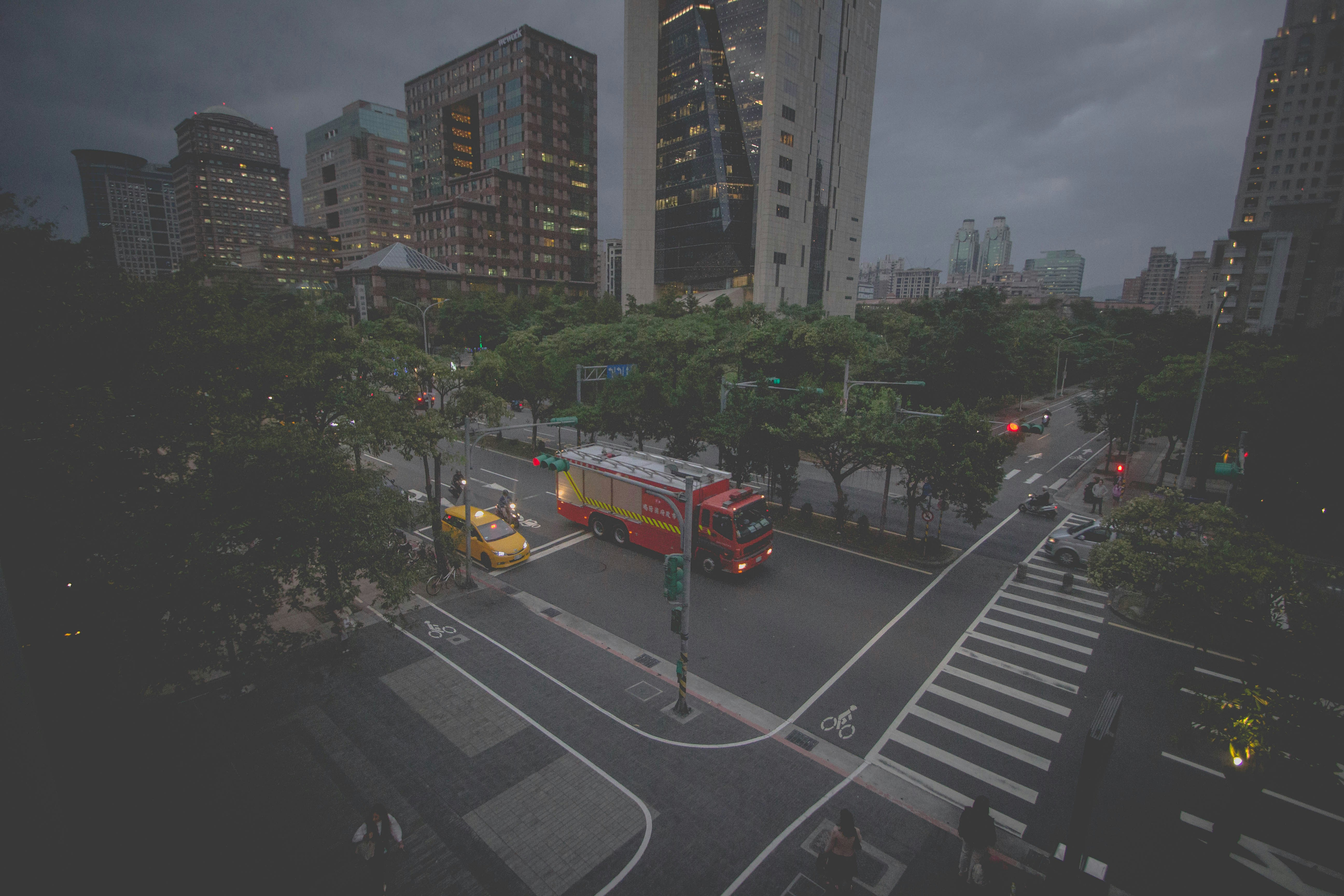Pulse at the Rainy Crossroads: Fire Truck at a Glassy Downtown Intersection