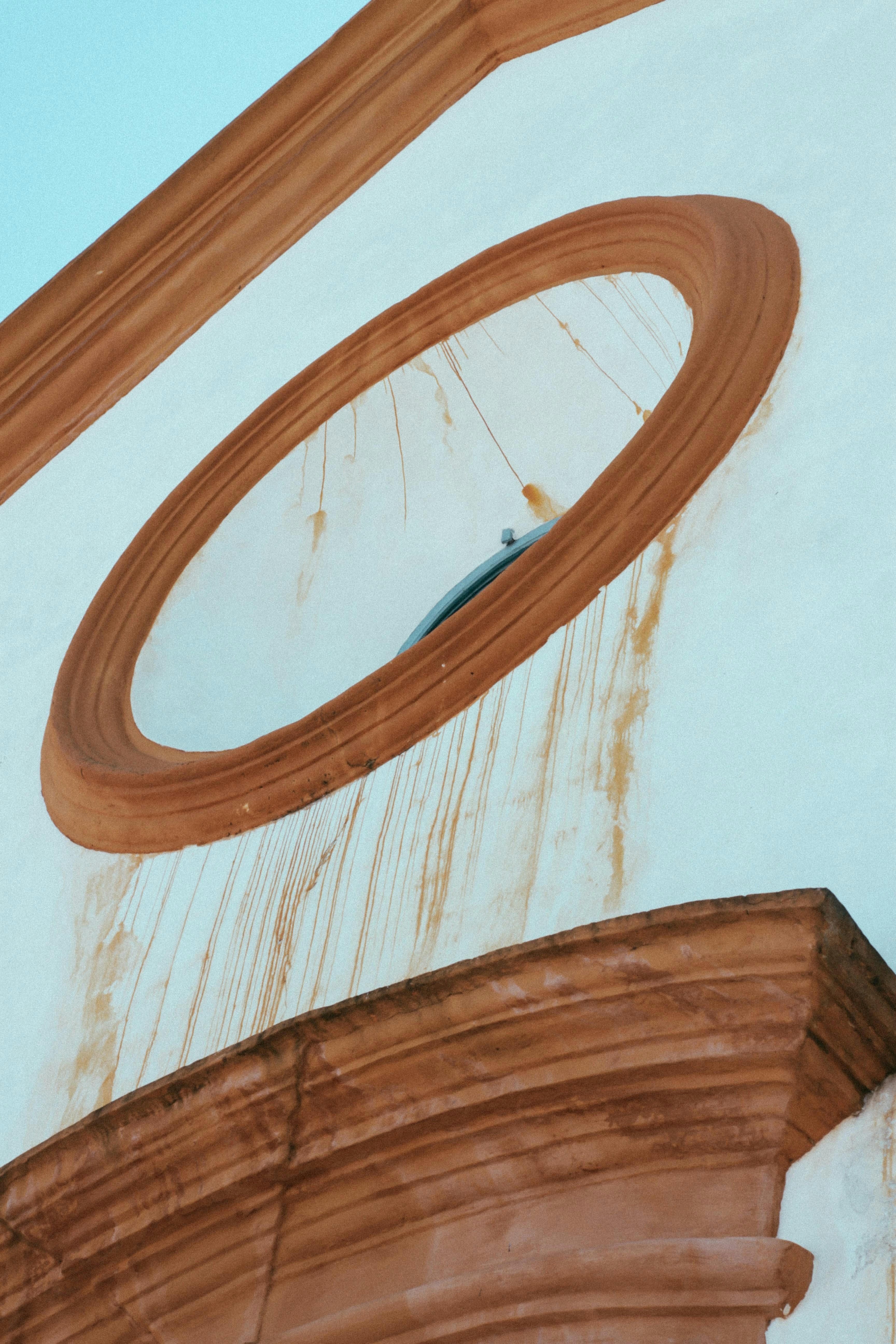 brown wooden spiral ladder on white wall