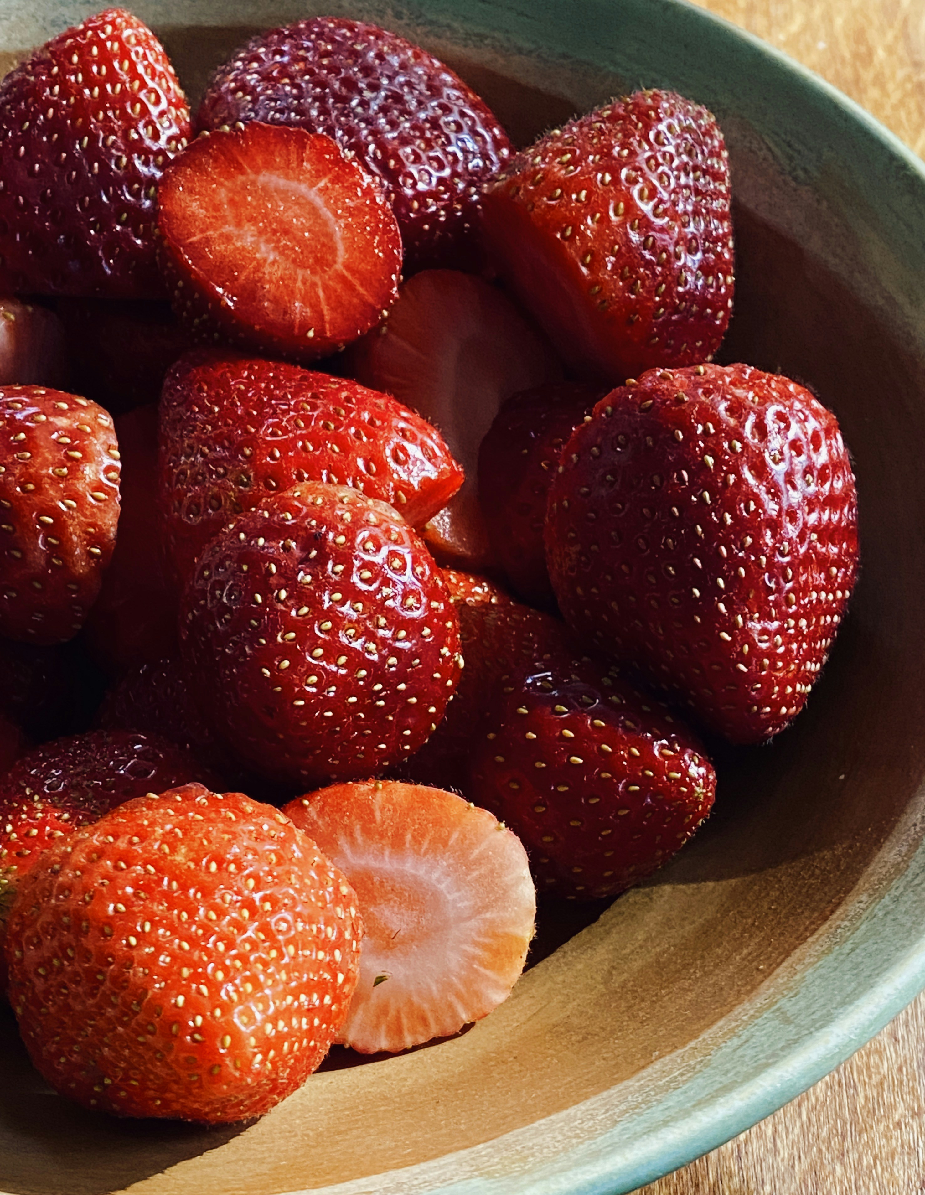 Crimson Drupelets in a Rustic Bowl: A Close-Up of Strawberry Harvest