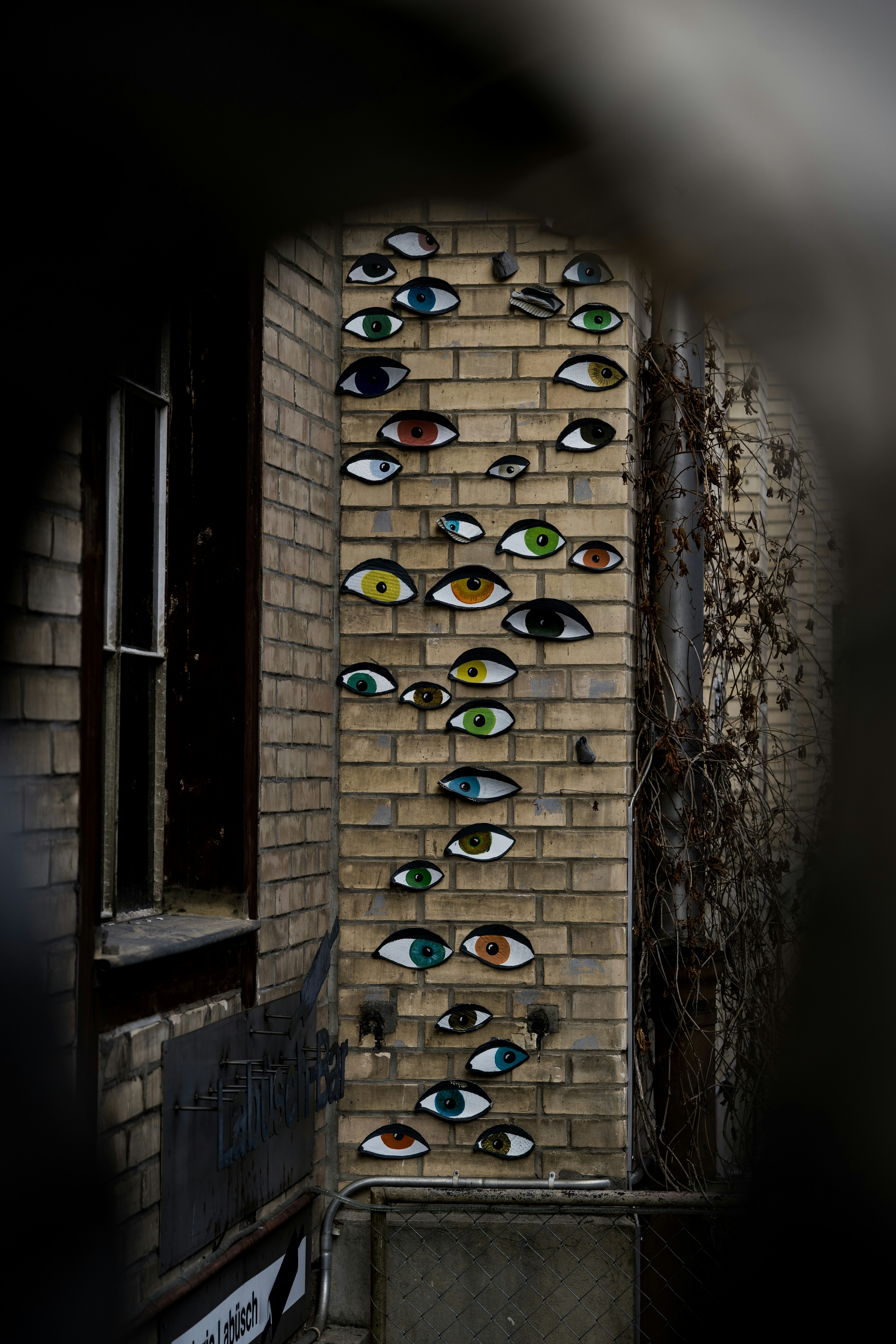 Eye Mosaic on a Brick Wall: A Corridor of Colors