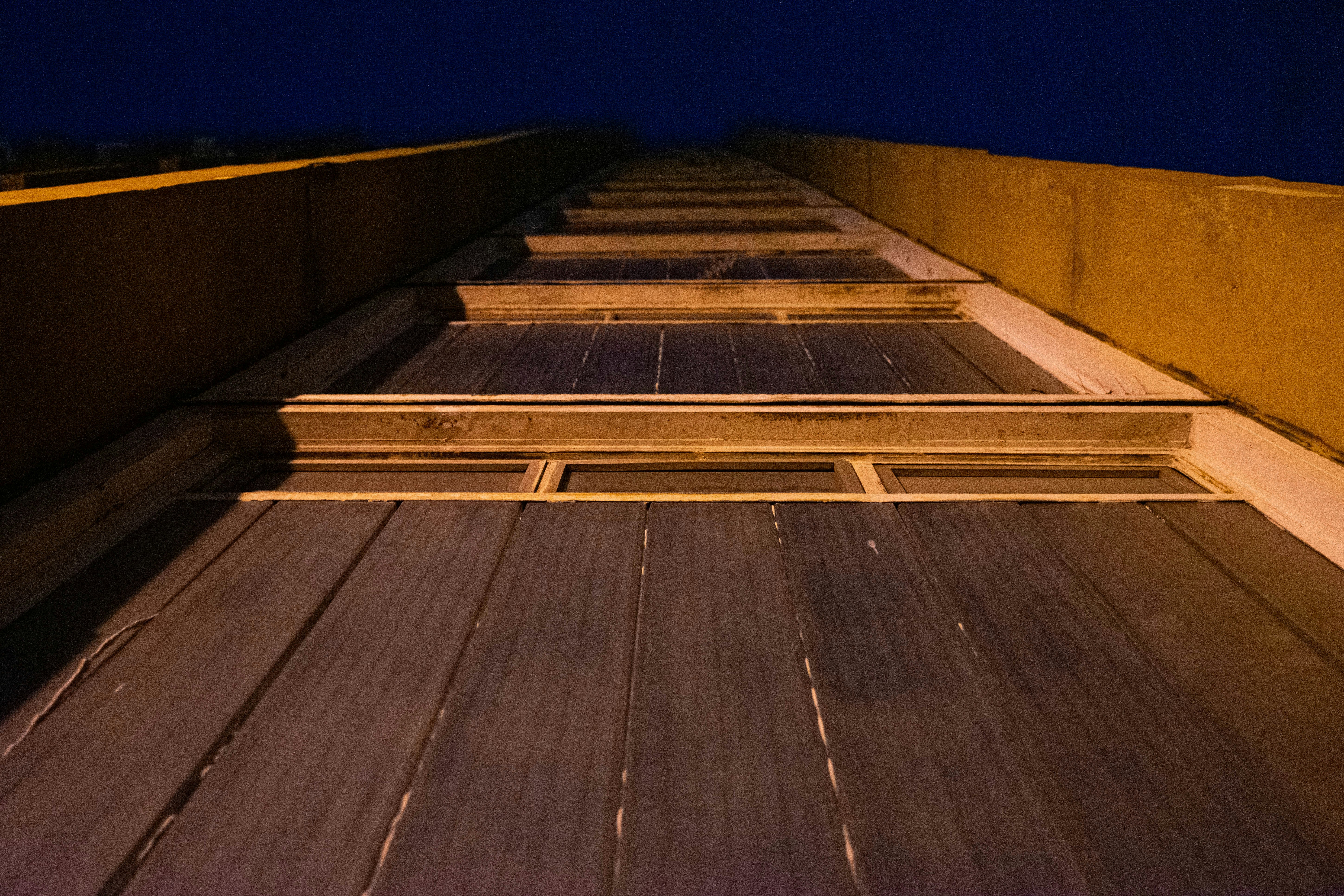 Vanishing Lines Up a Night-Warmed Facade