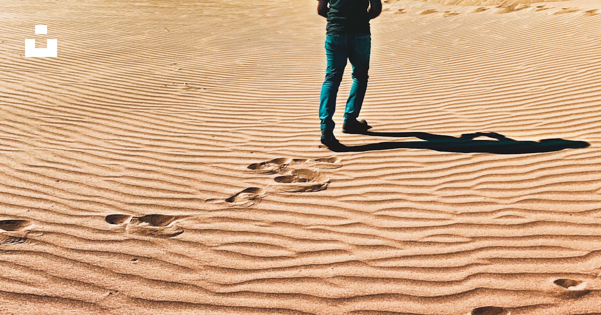 Man In Black Jacket Walking On Brown Sand During Daytime Photo Free