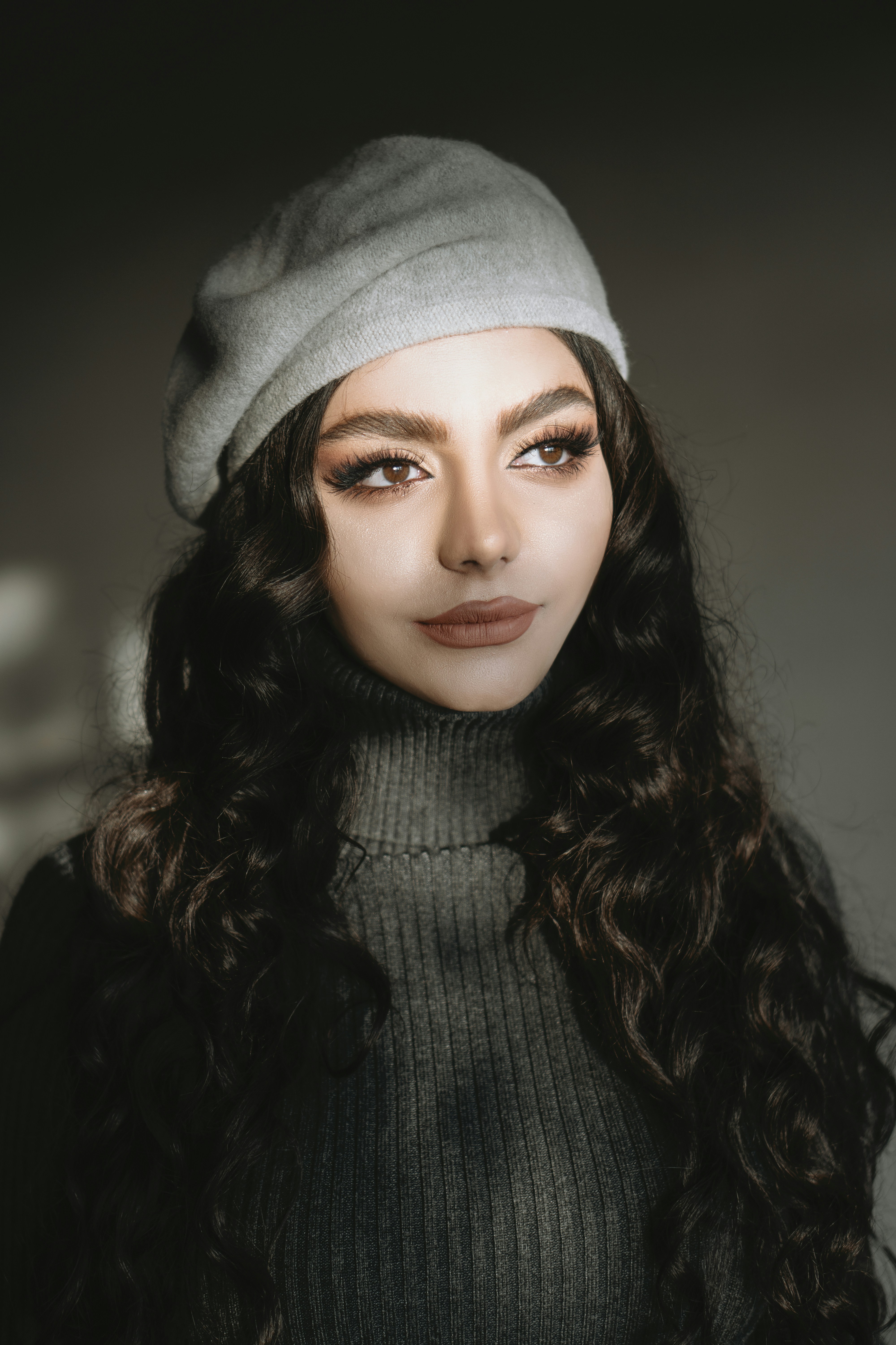 woman in gray knit cap and black coat