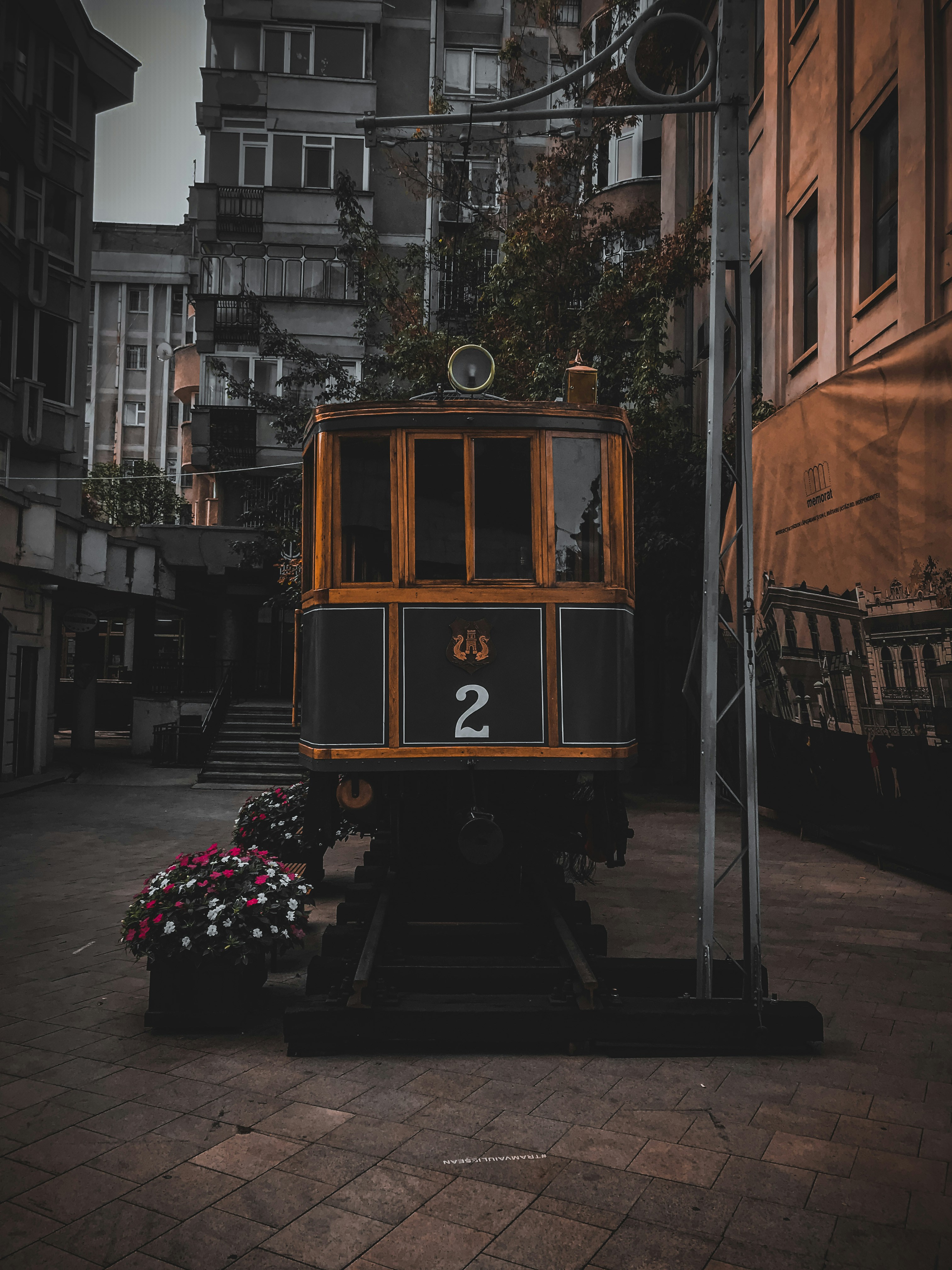 Echoes of the Line: A Vintage Tram in a Moody City Courtyard