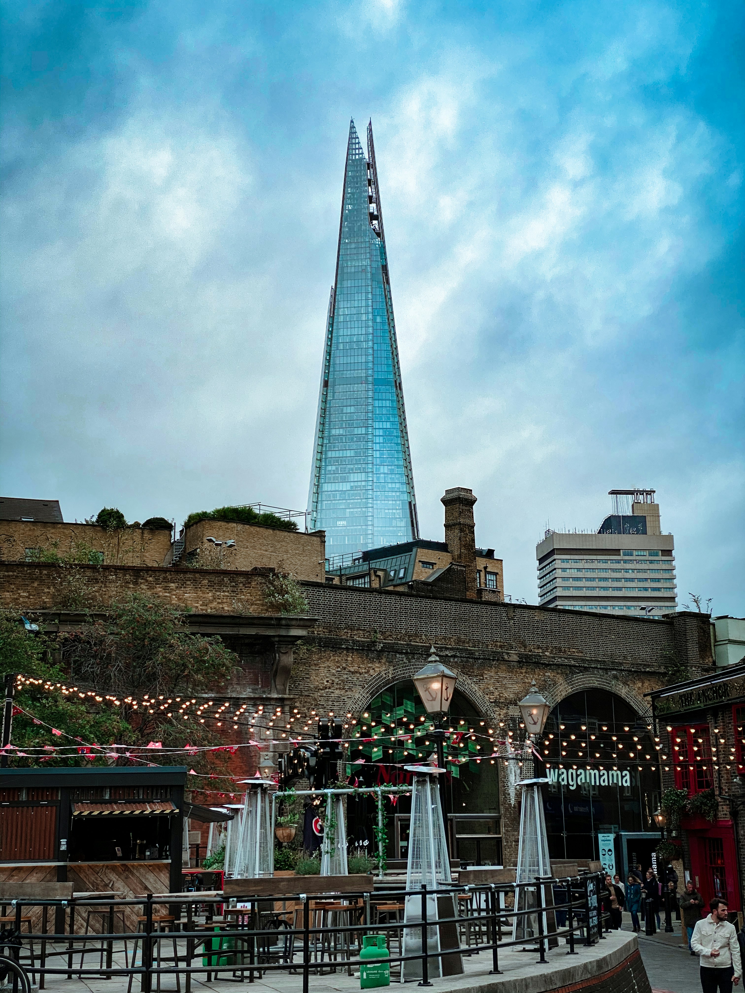 Towering Glass: The Shard Rising Above a Historic Riverside Scene