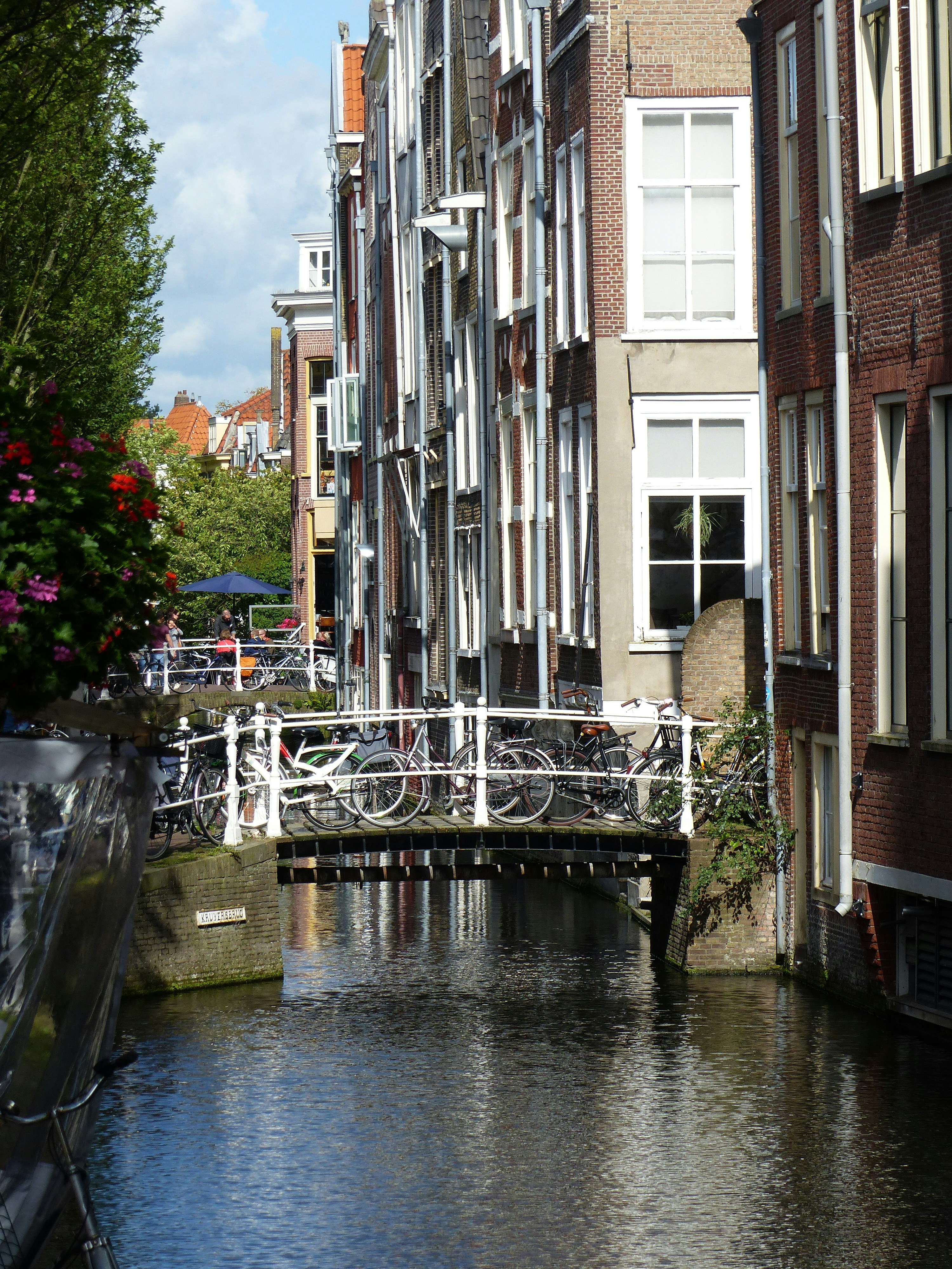 White metal bridge over river between buildings during daytime photo ...