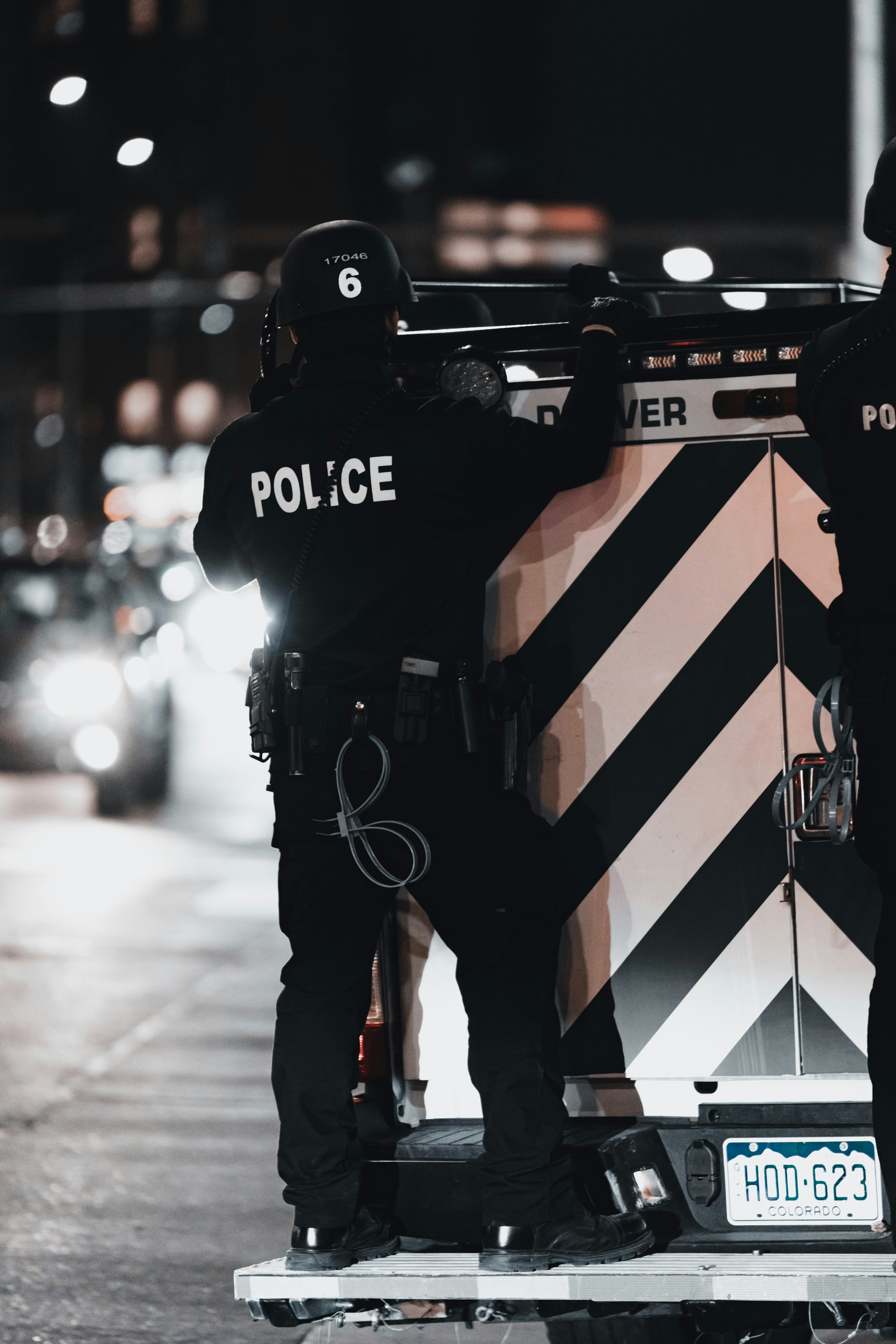 Two police officers standing next to a police car photo – Free Black ...