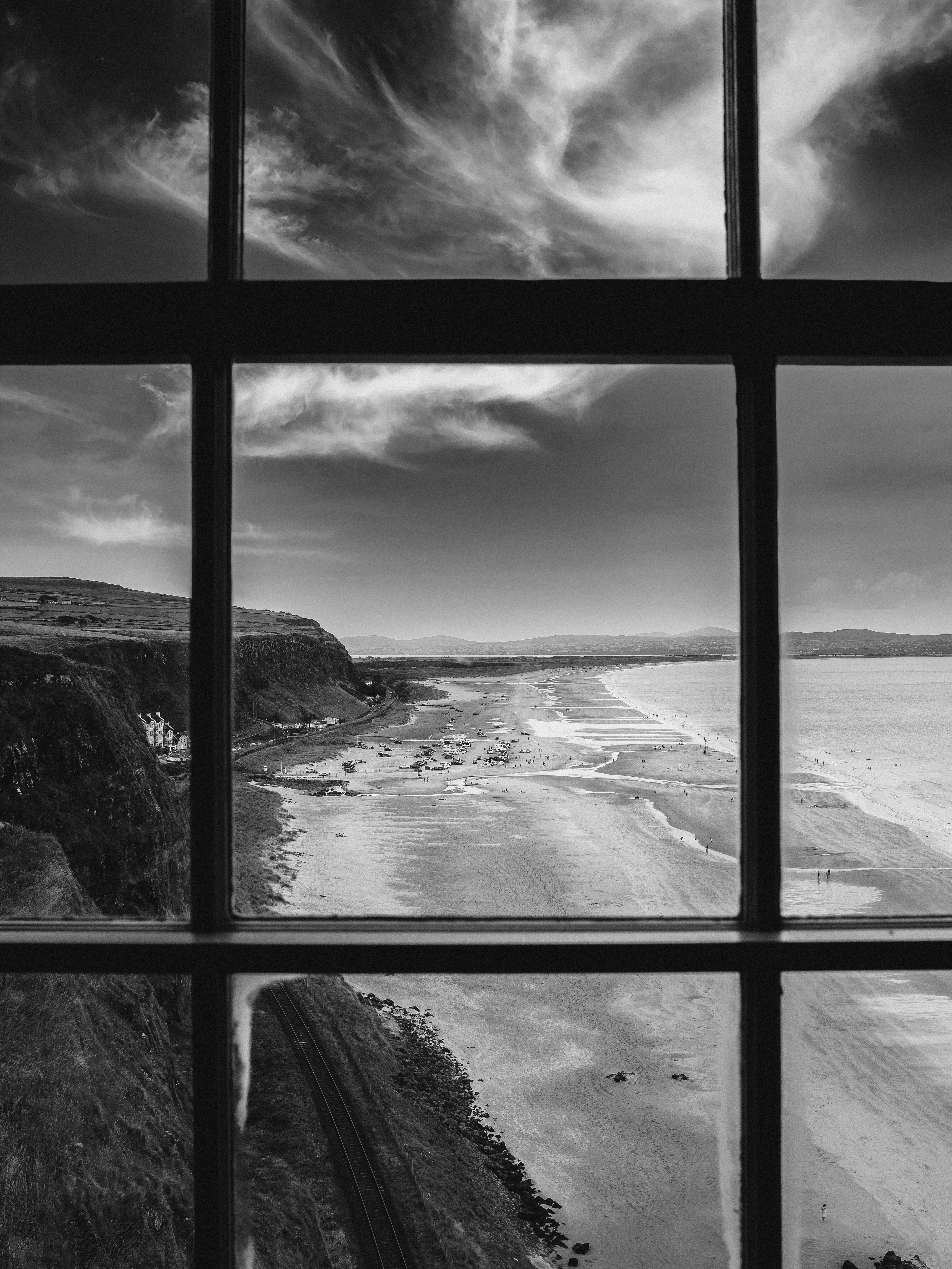 Window to the Coast: A Black-and-White View Through Gridpanes