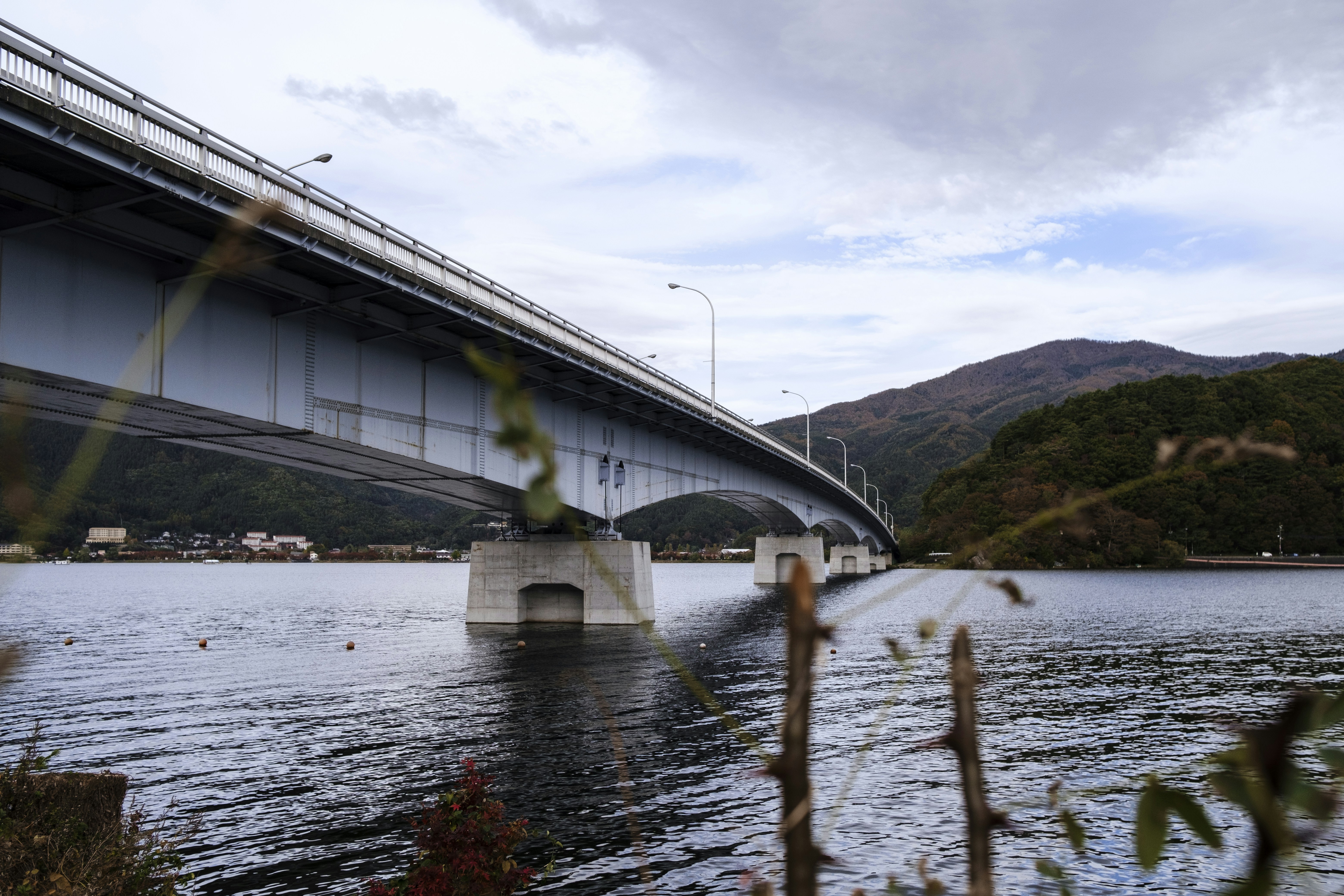 Span of Quiet Light: A Riverside Bridge Framed by Hills