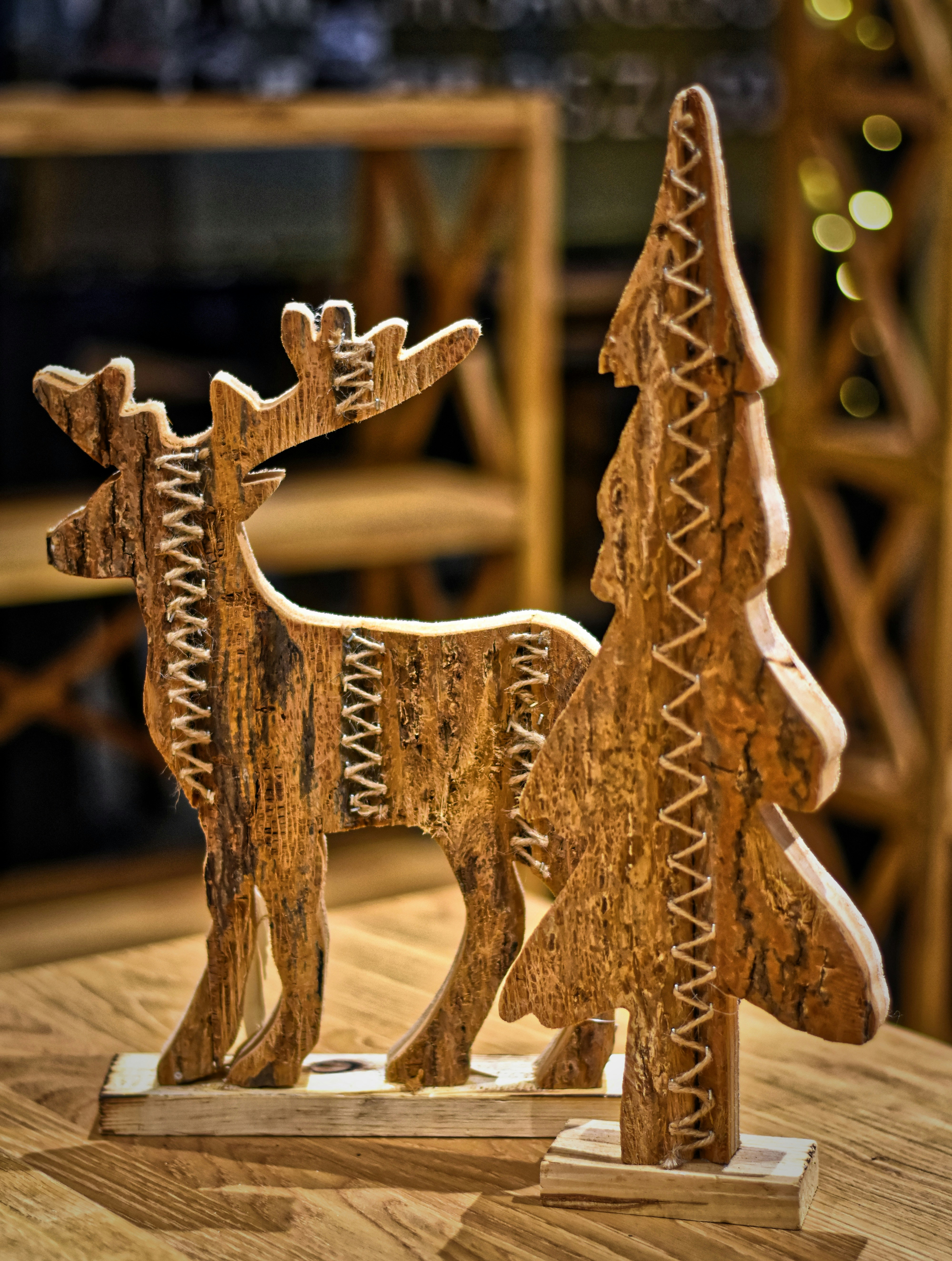 Stitched Woodland Duo: Hand-Carved Reindeer and Pine in Warm Studio Light