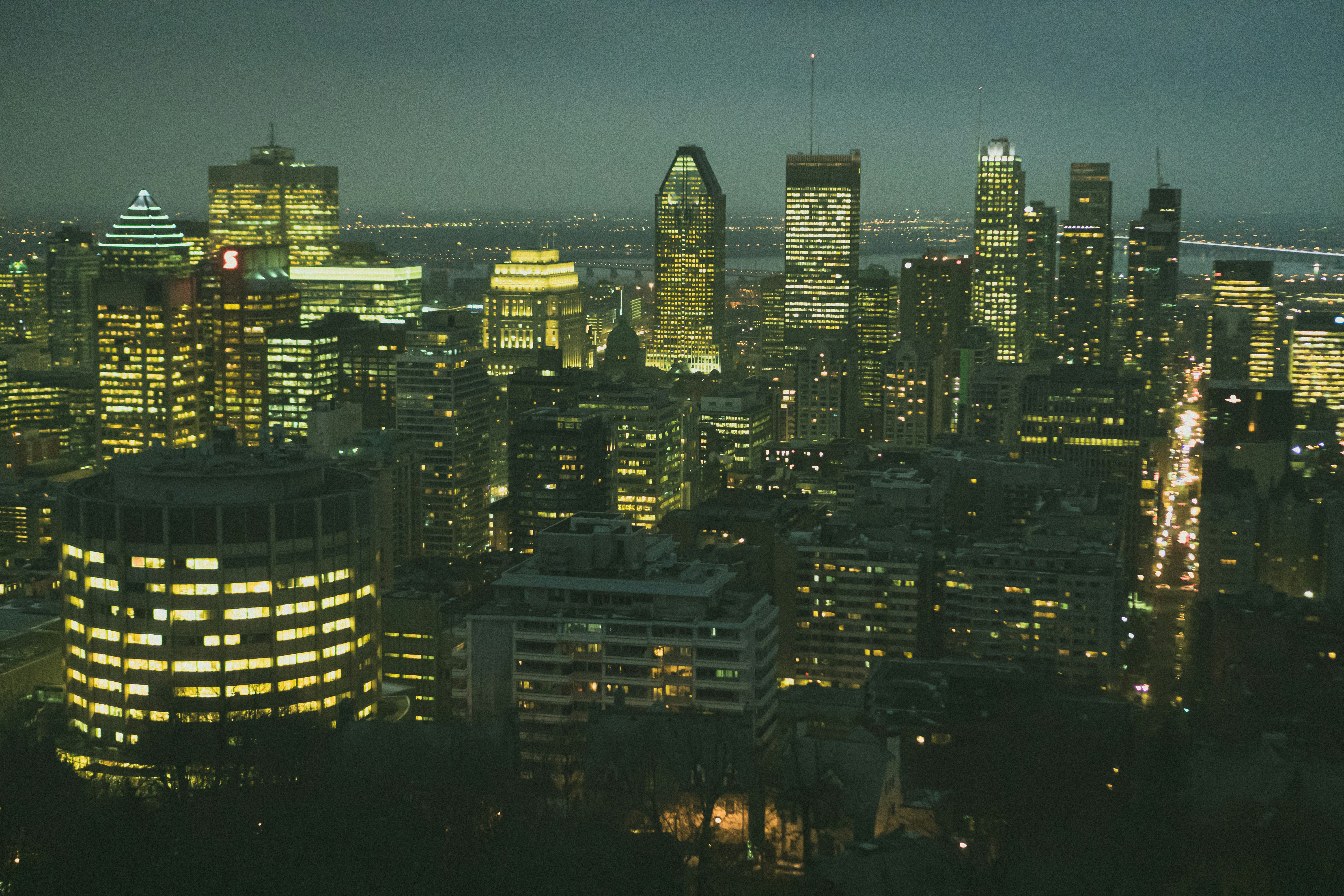 Nocturnal Skyline: Golden Windows Thread a Distant Cityscape