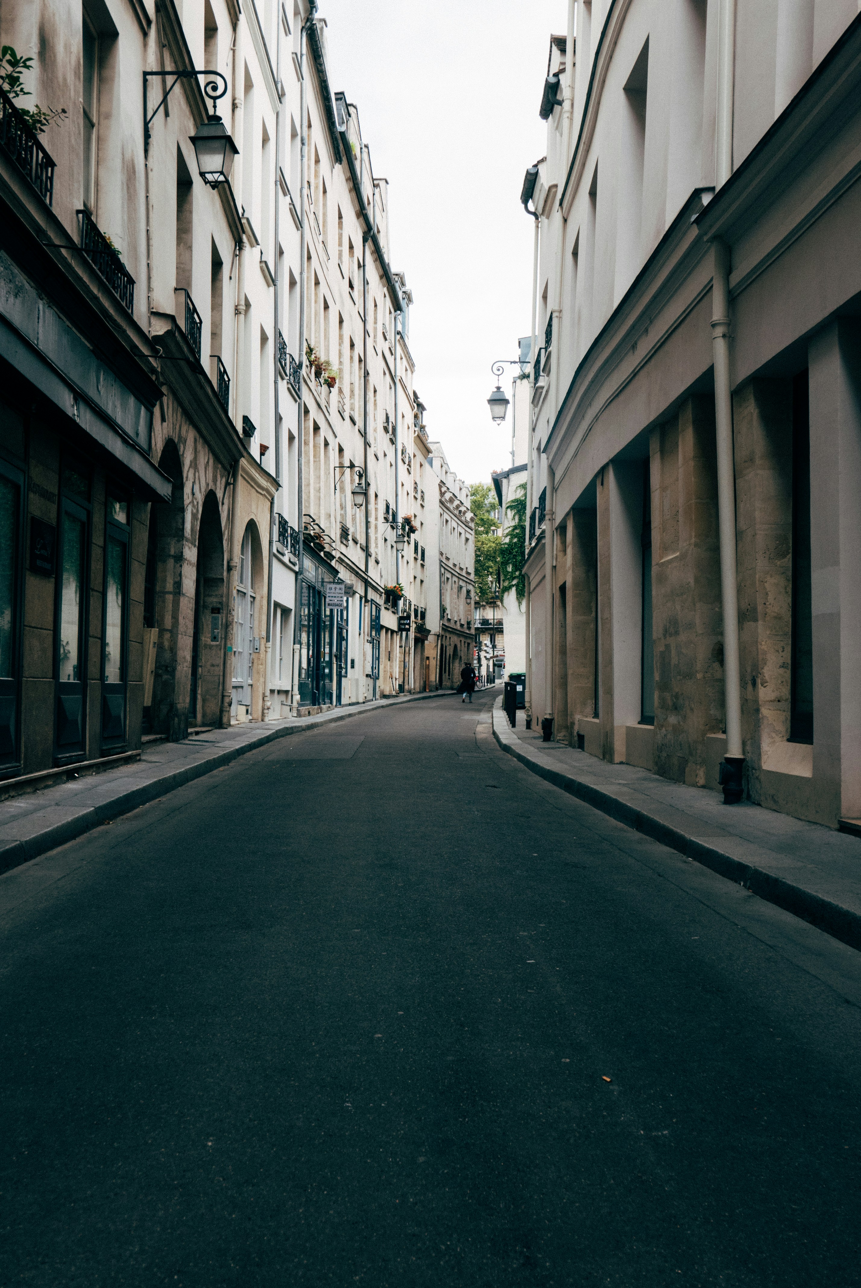 Empty road between concrete buildings during daytime photo – Free ...