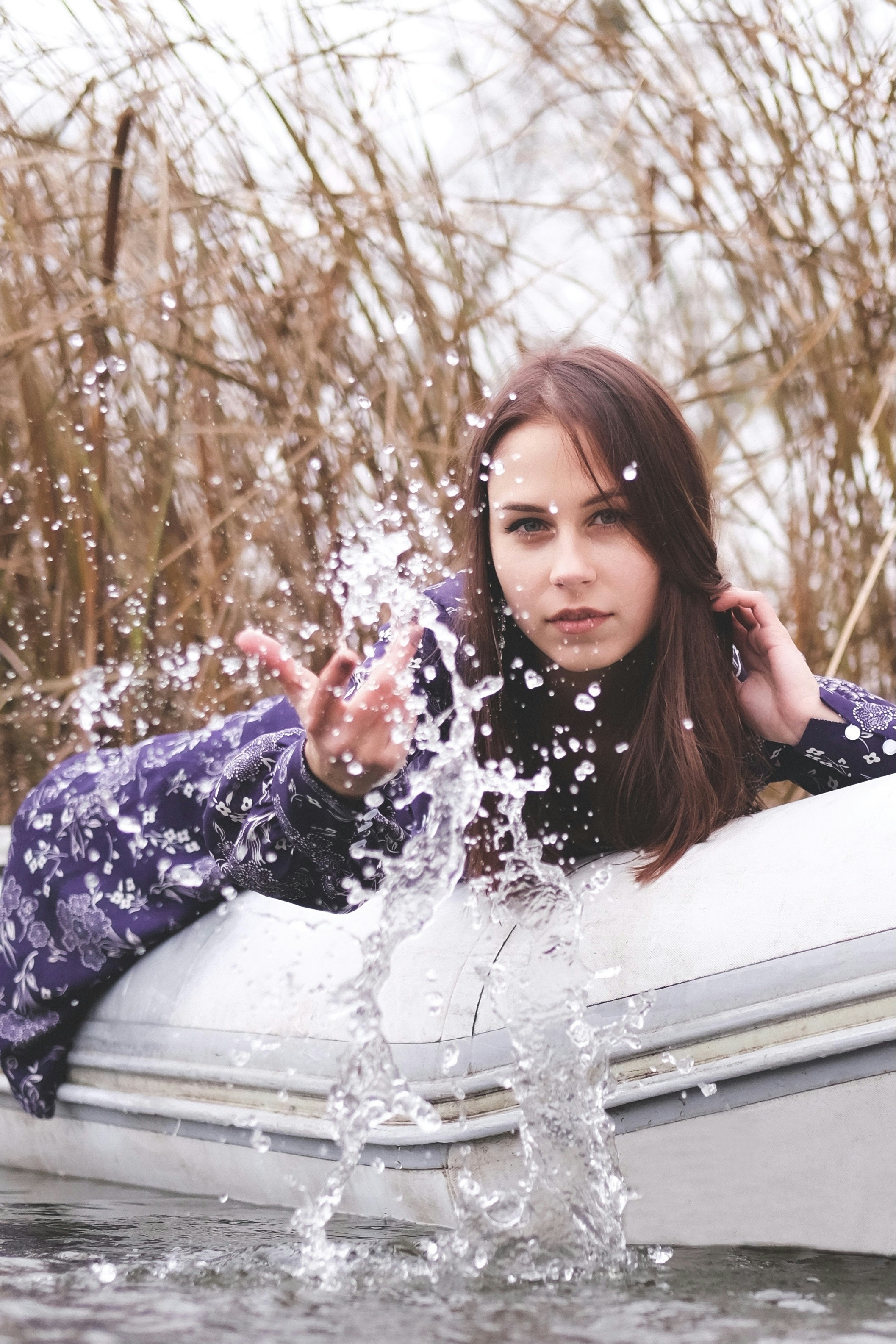 Spray and Gaze: Portrait on a Boat Amid Water's Burst