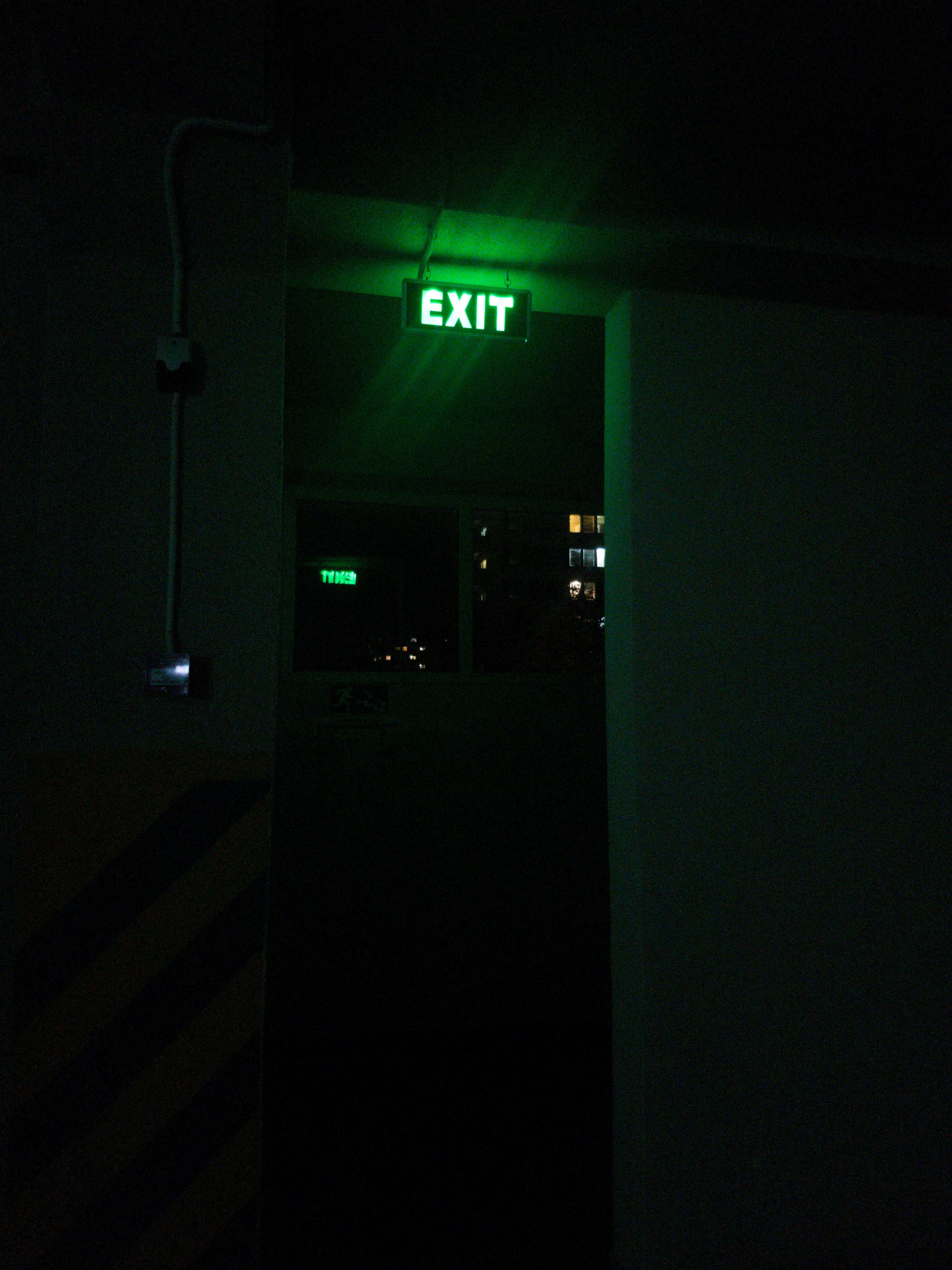 a exit sign lit up in the darkAlex Kalinin