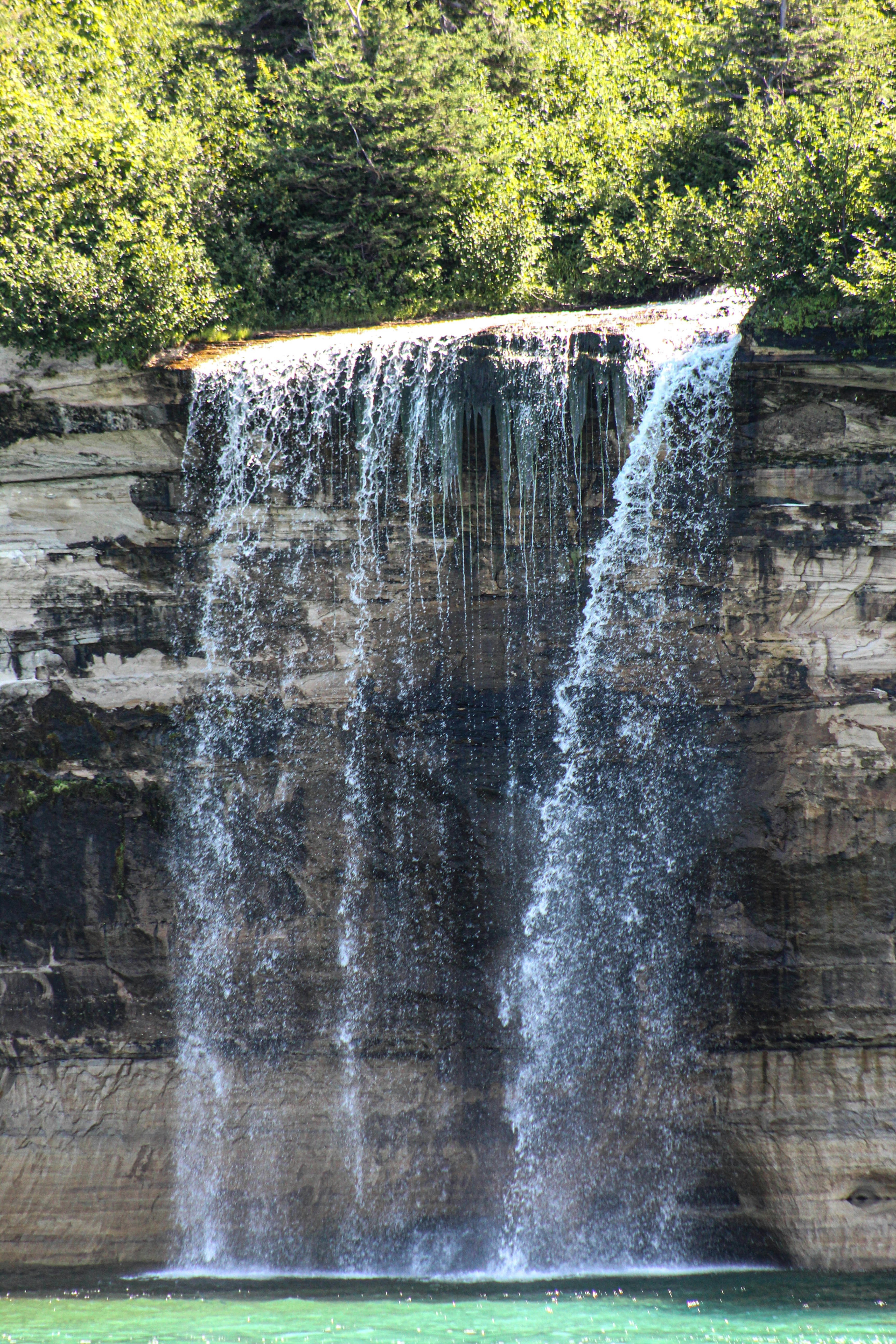 water falls in the middle of the forest