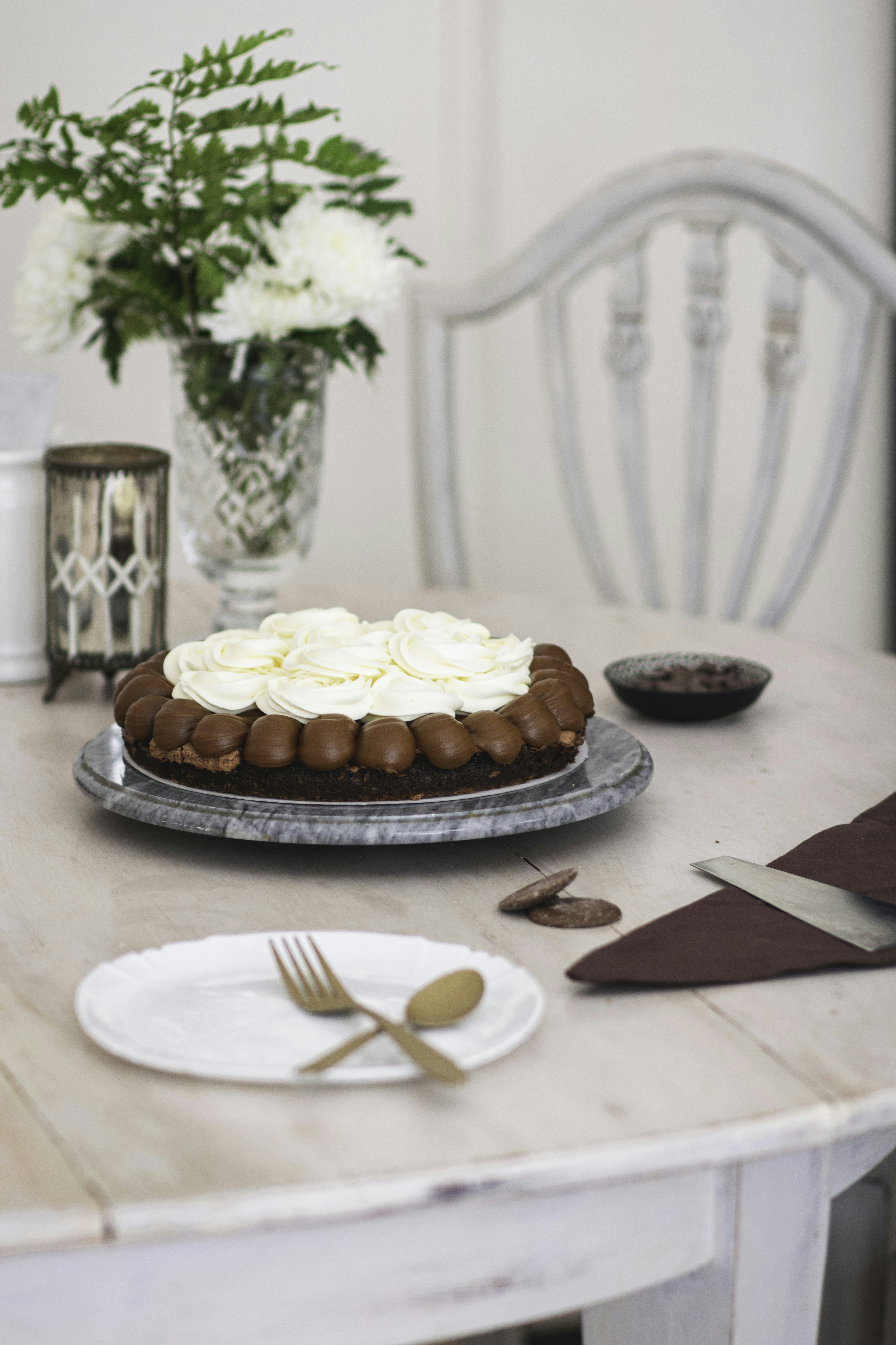 Rosette-Chocolate Cake on a Weathered White Table