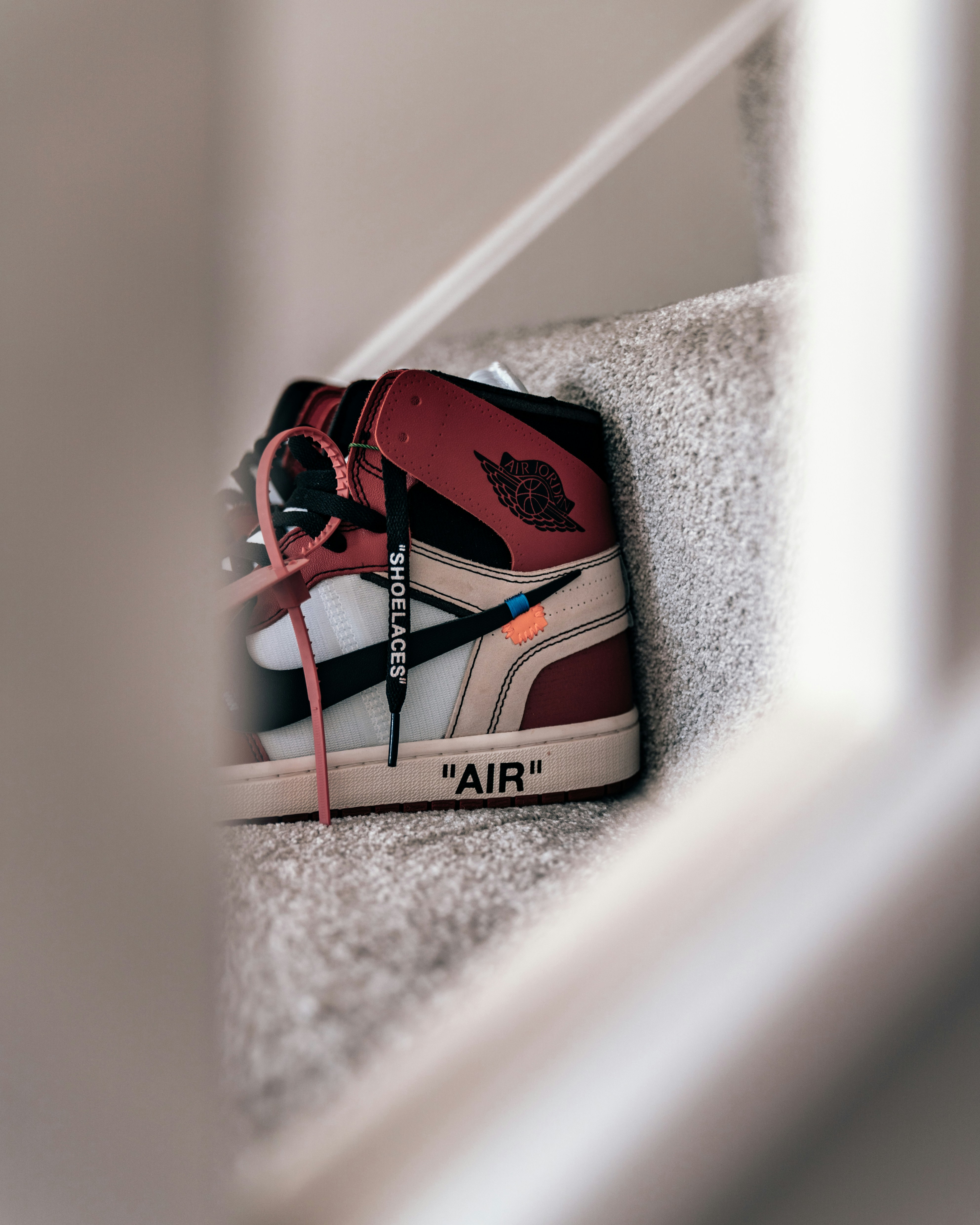 Air on the Landing: A close-up of a sneaker peeking from the stair