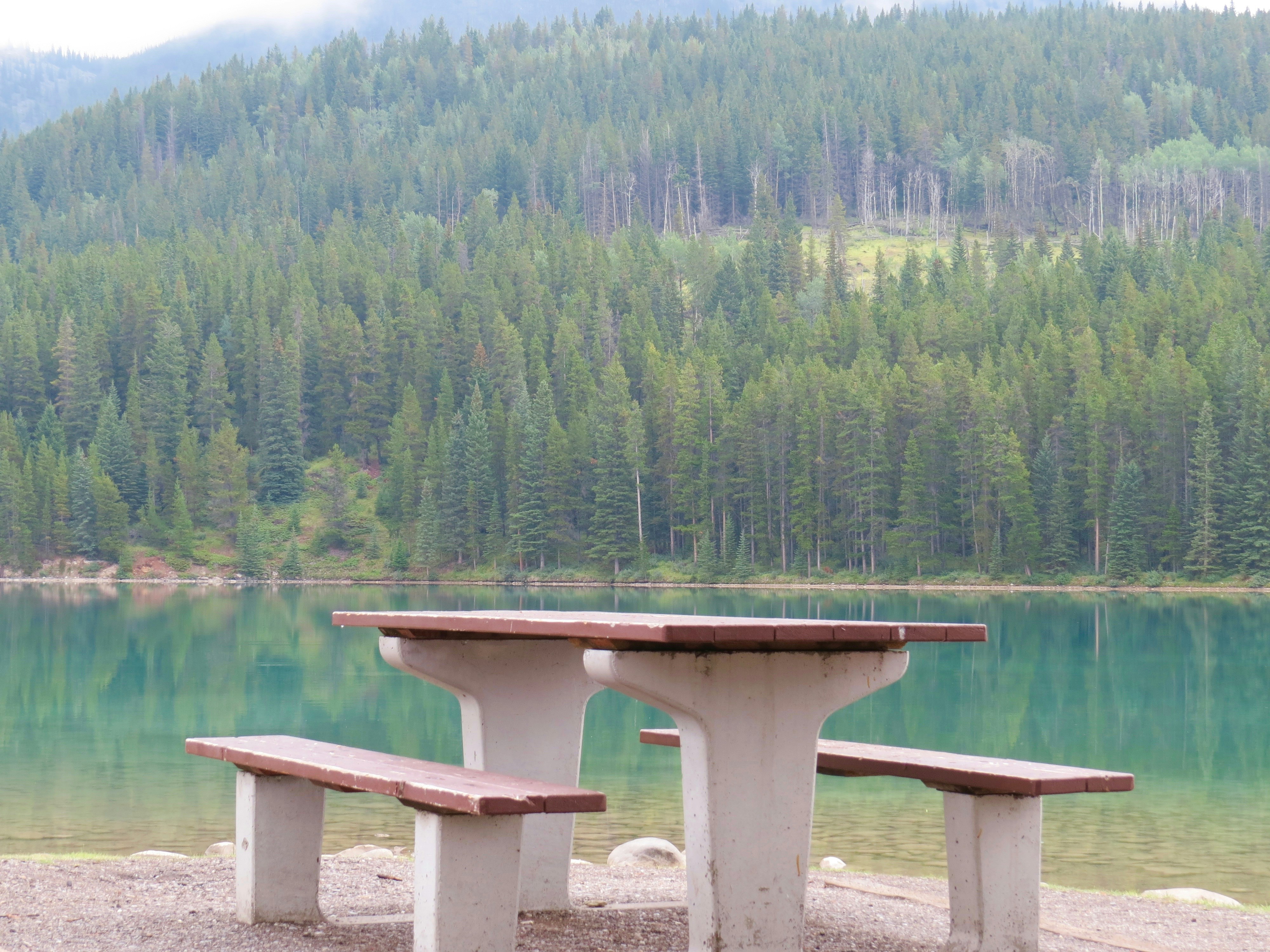 Solitary Picnic Table Overlooking a Turquoise Alpine Lake