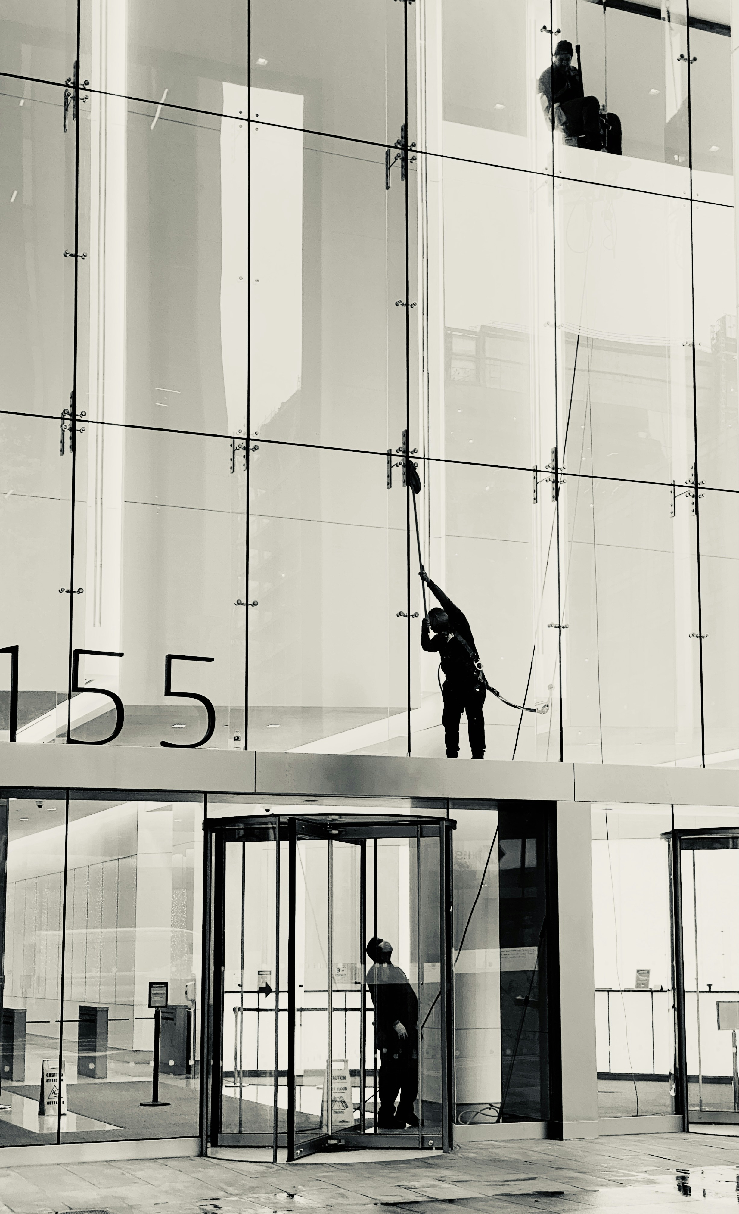 Man in black jacket and pants standing on glass window photo – Free ...