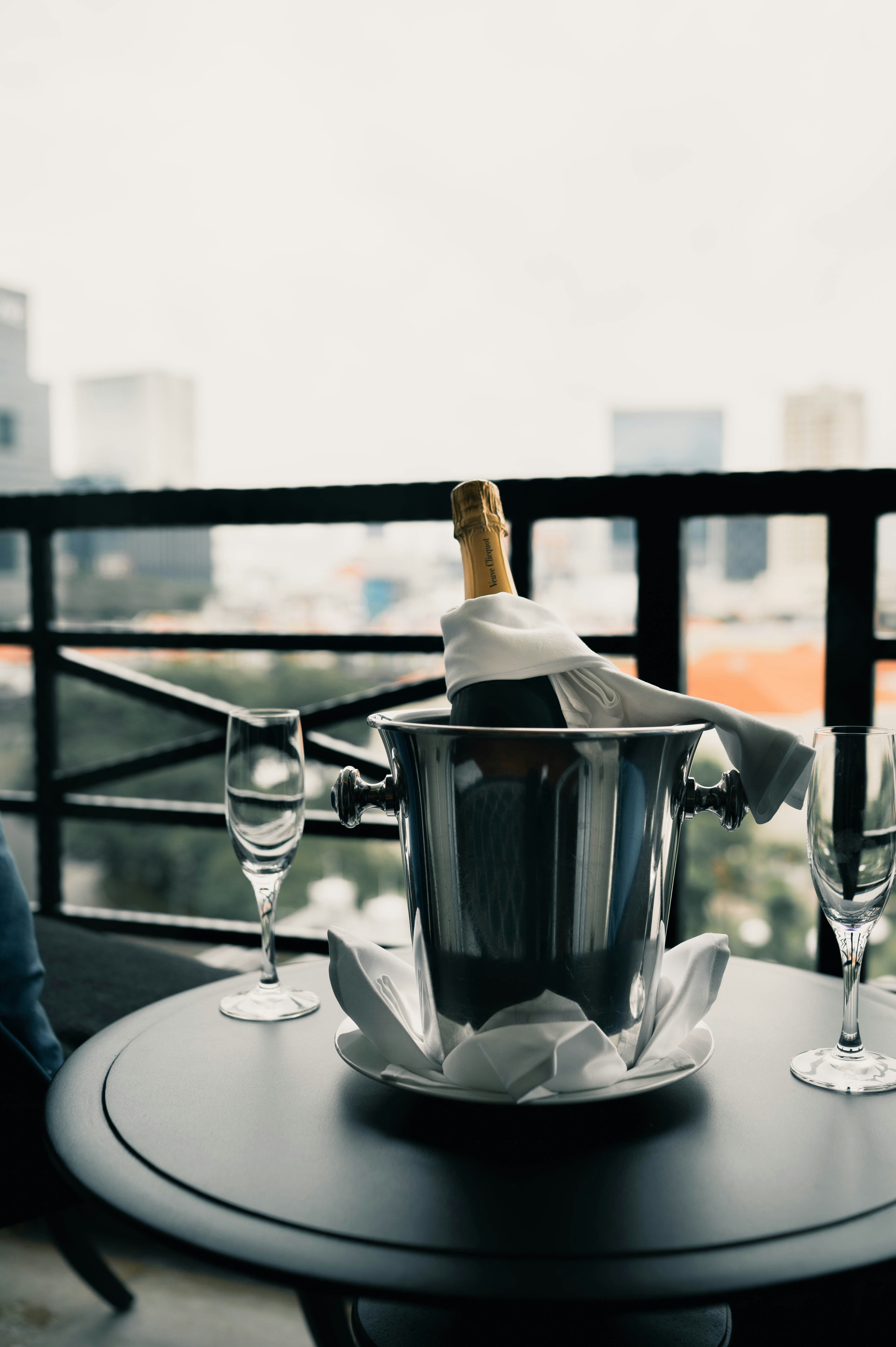 Silver Bucket Serenade: Champagne on a city balcony at dusk