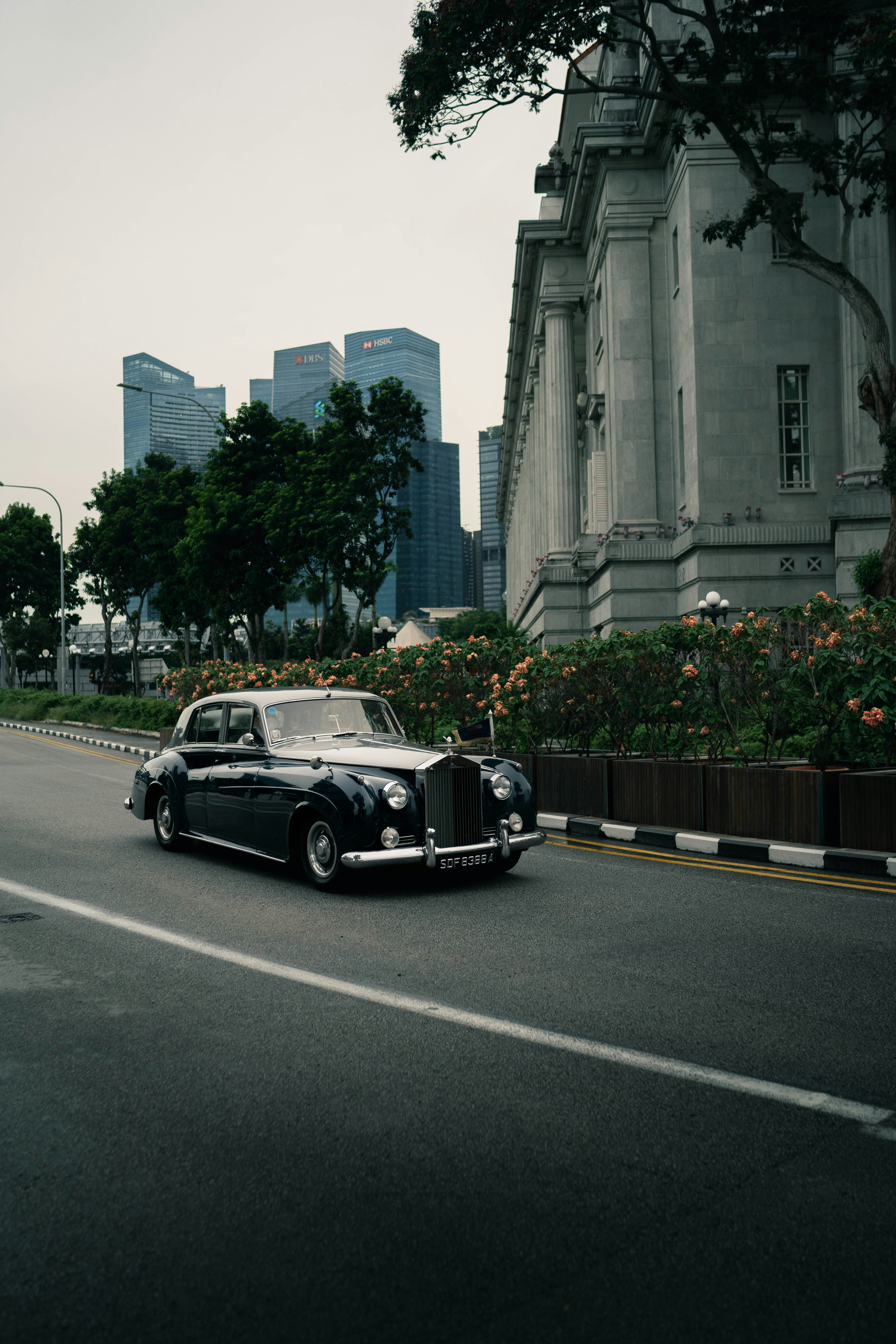 Black classic car on road near high rise buildings during daytime photo ...