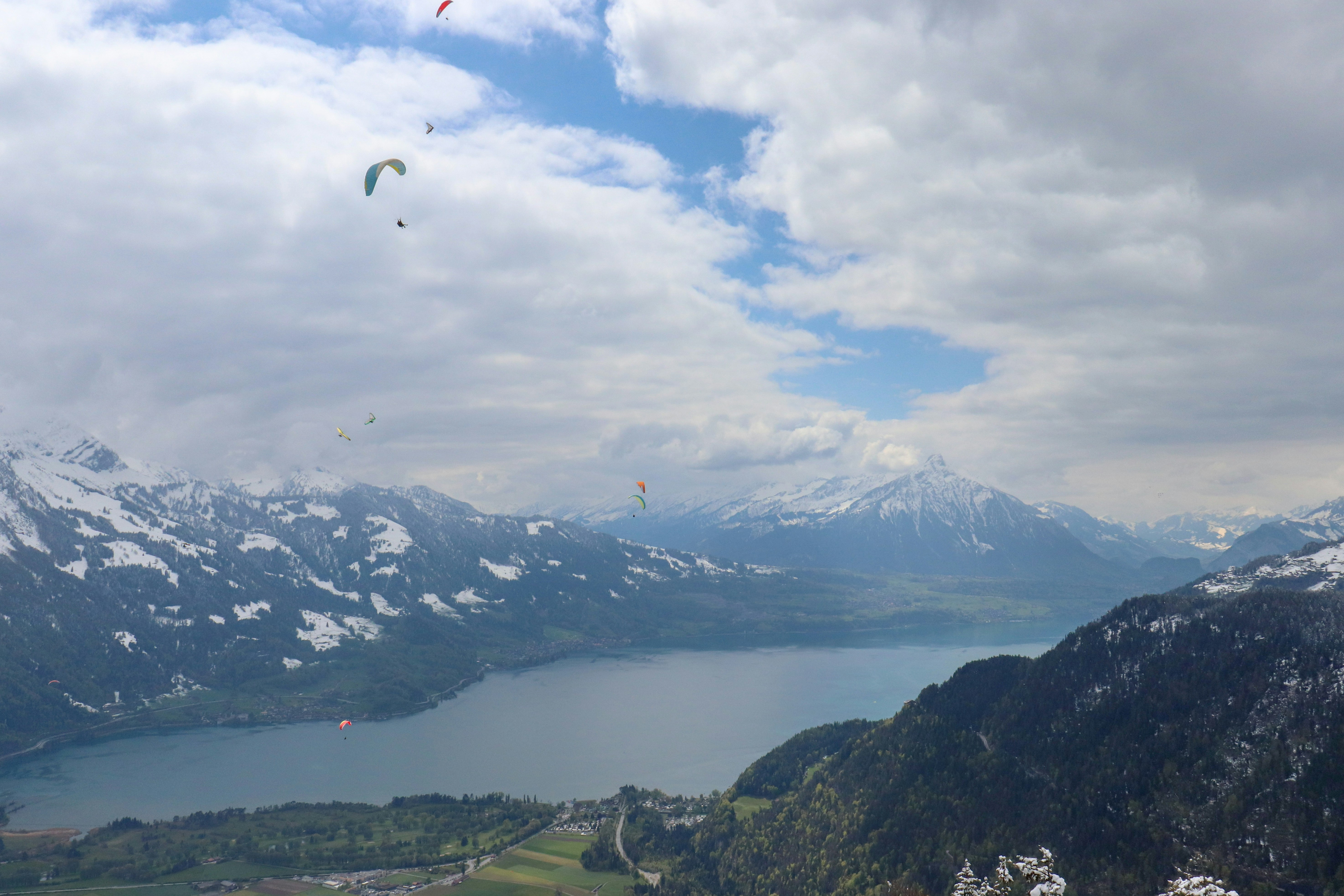 person in parachute over the mountains during daytime