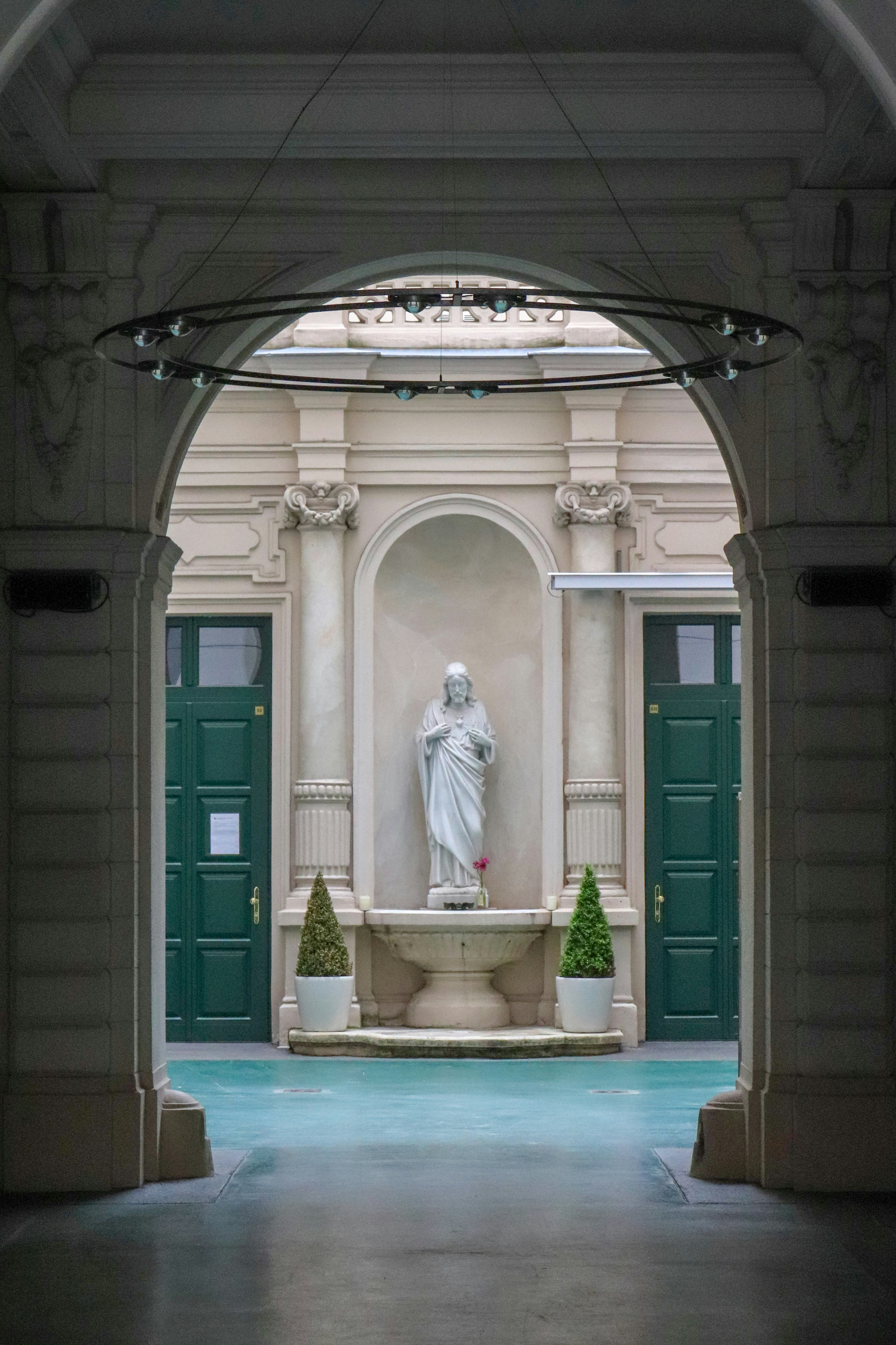 White concrete statue in front of white concrete building photo – Free ...