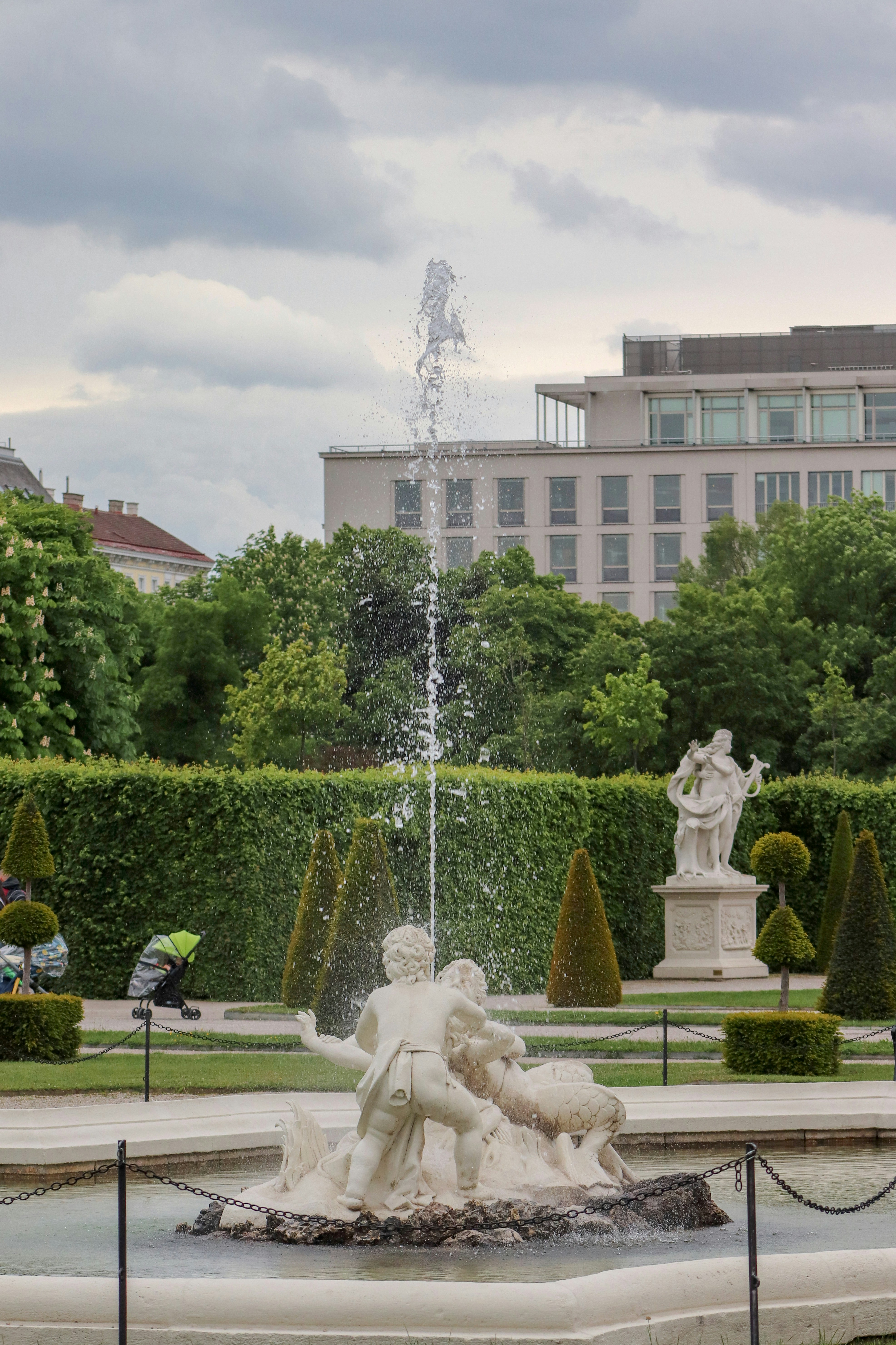Centerpiece Cascade: Marble Cherubs Framed by a Soaring Fountain in a Formal Park