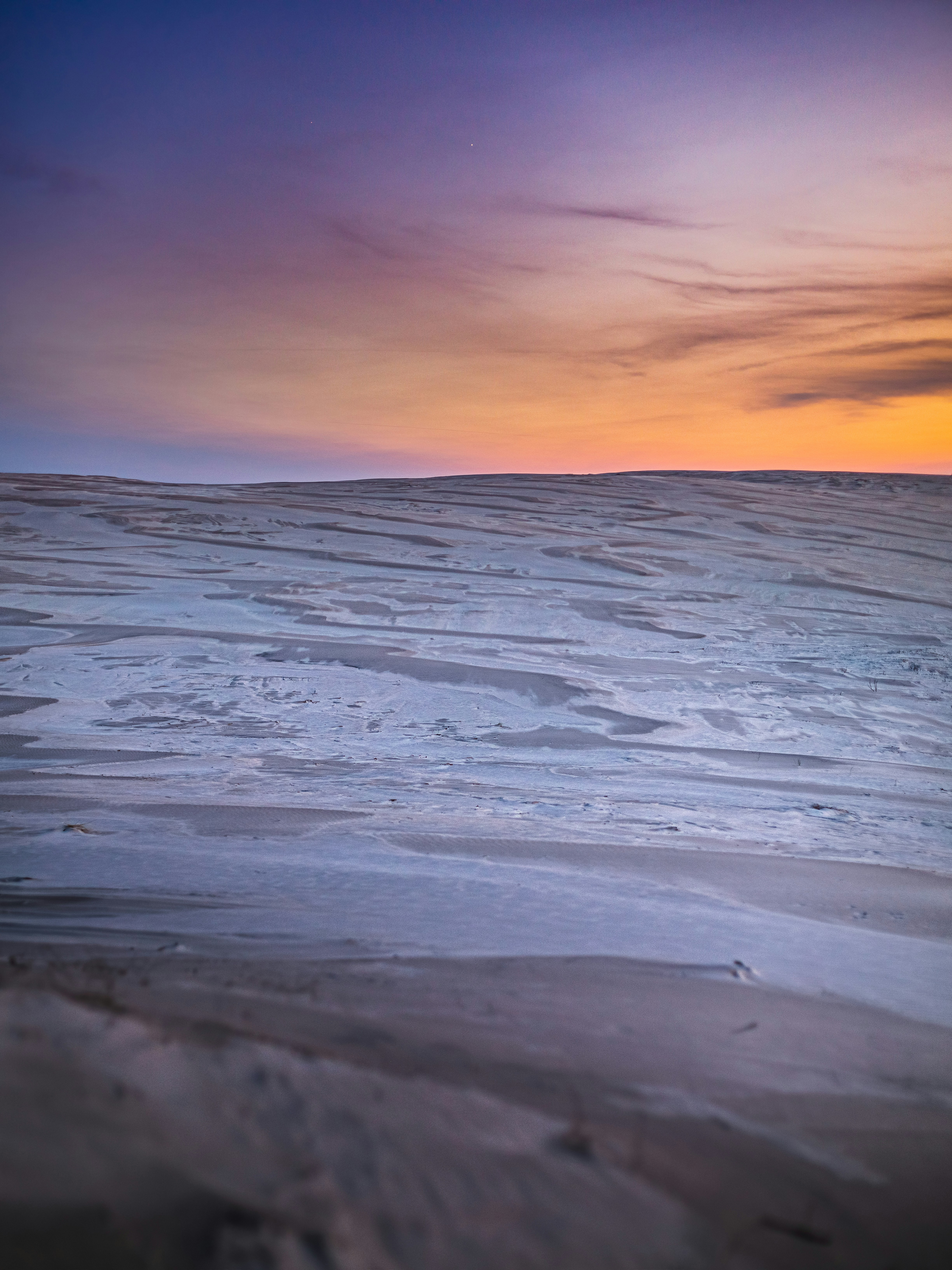 Dusk on the Dunes: Wind-Patterned Sands Meet a Velvet Horizon