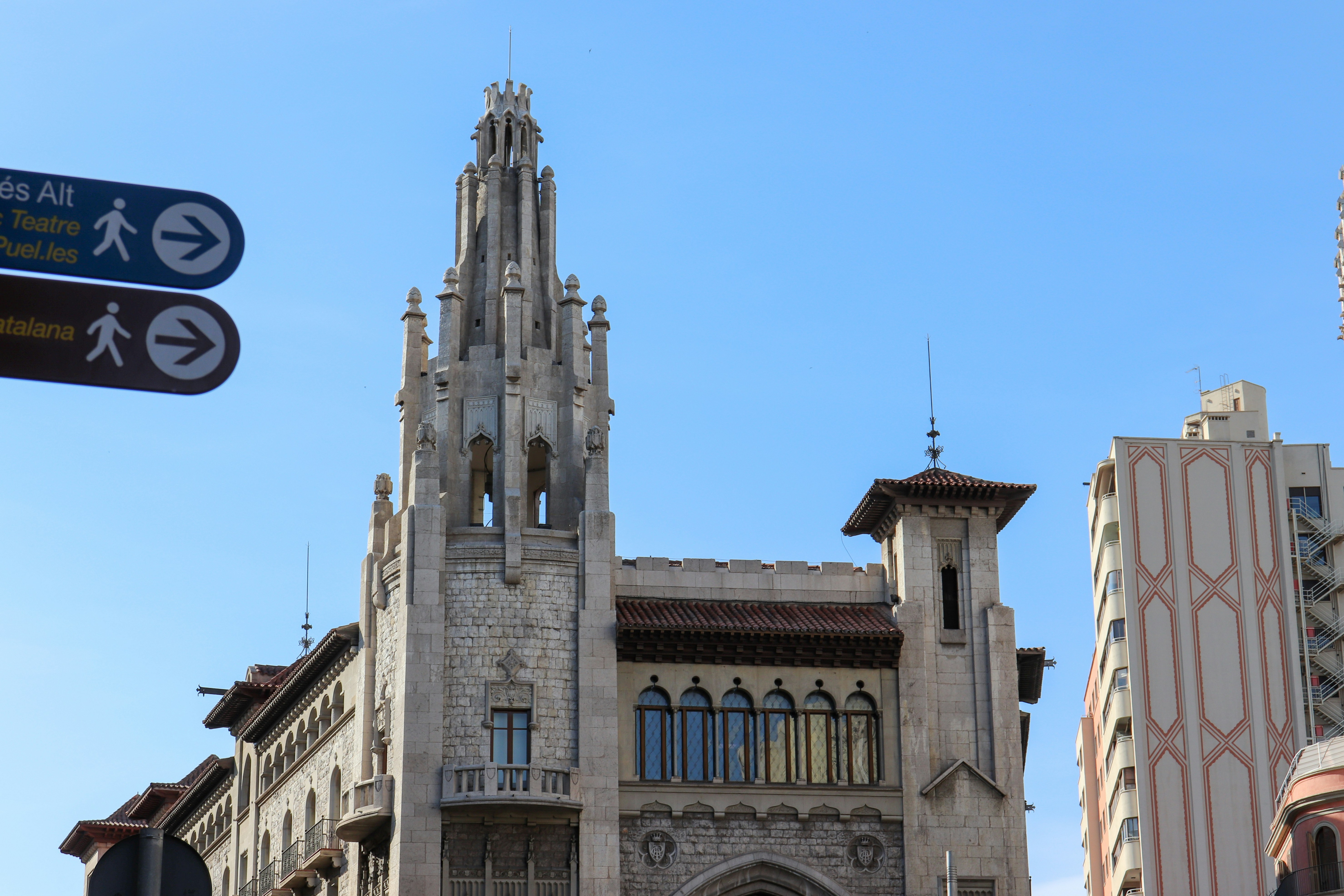 Gothic Tower Overlooks a Sunlit City Street