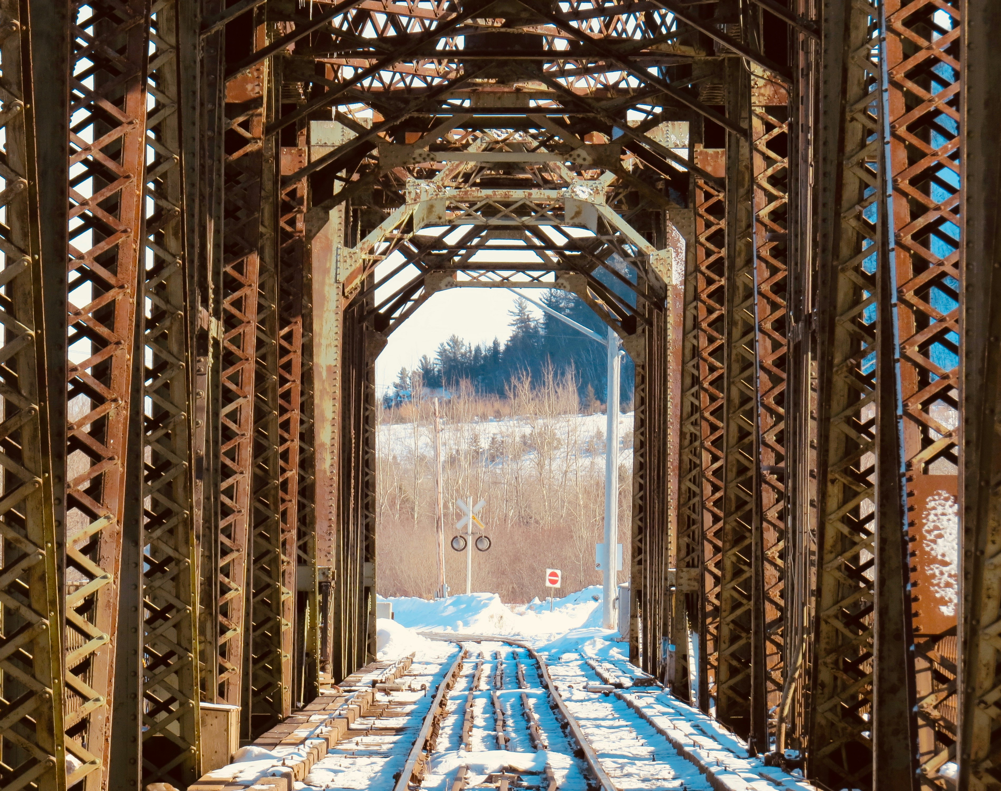 Rusted Iron Corridor: Snow-Cleared Rails Recede Toward a Distant Horizon