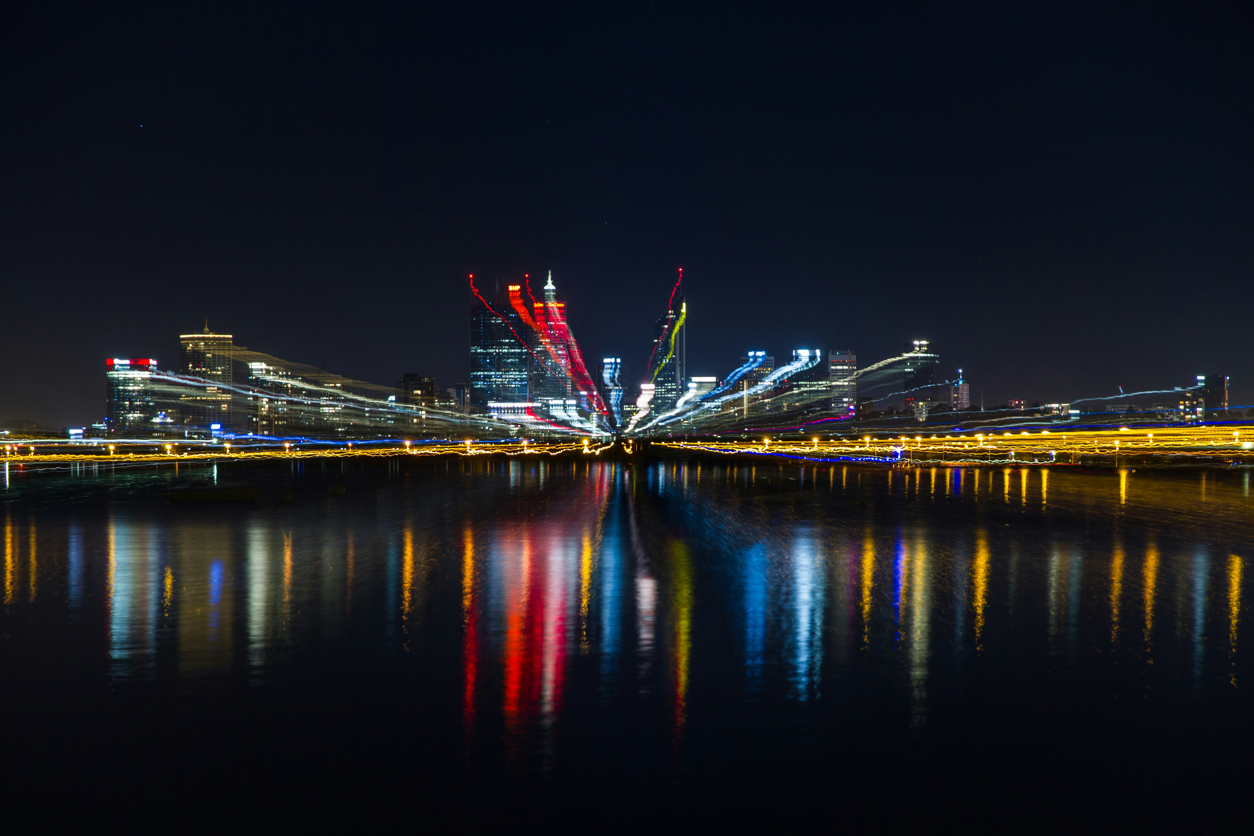 Urban Symphony: Light Trails over Water