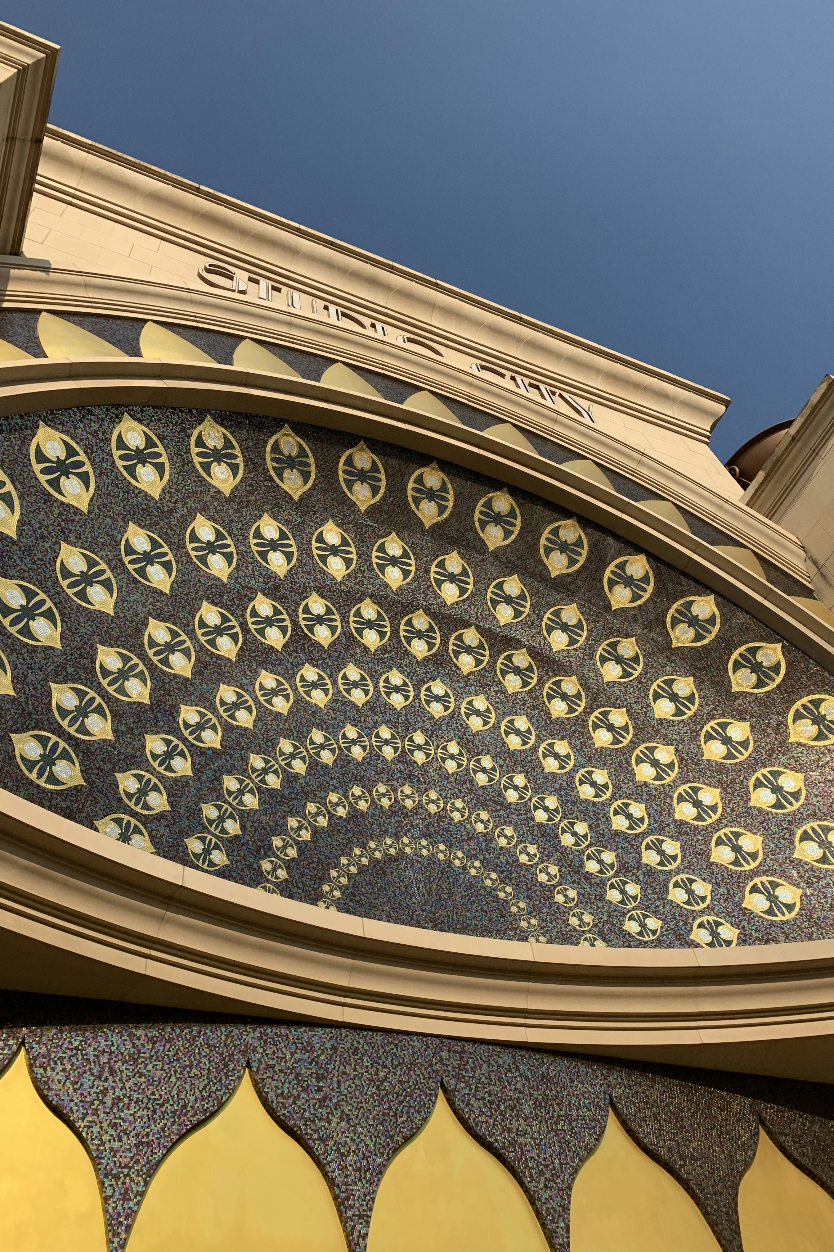 Spiral of Gold Echoes on a Classical Facade