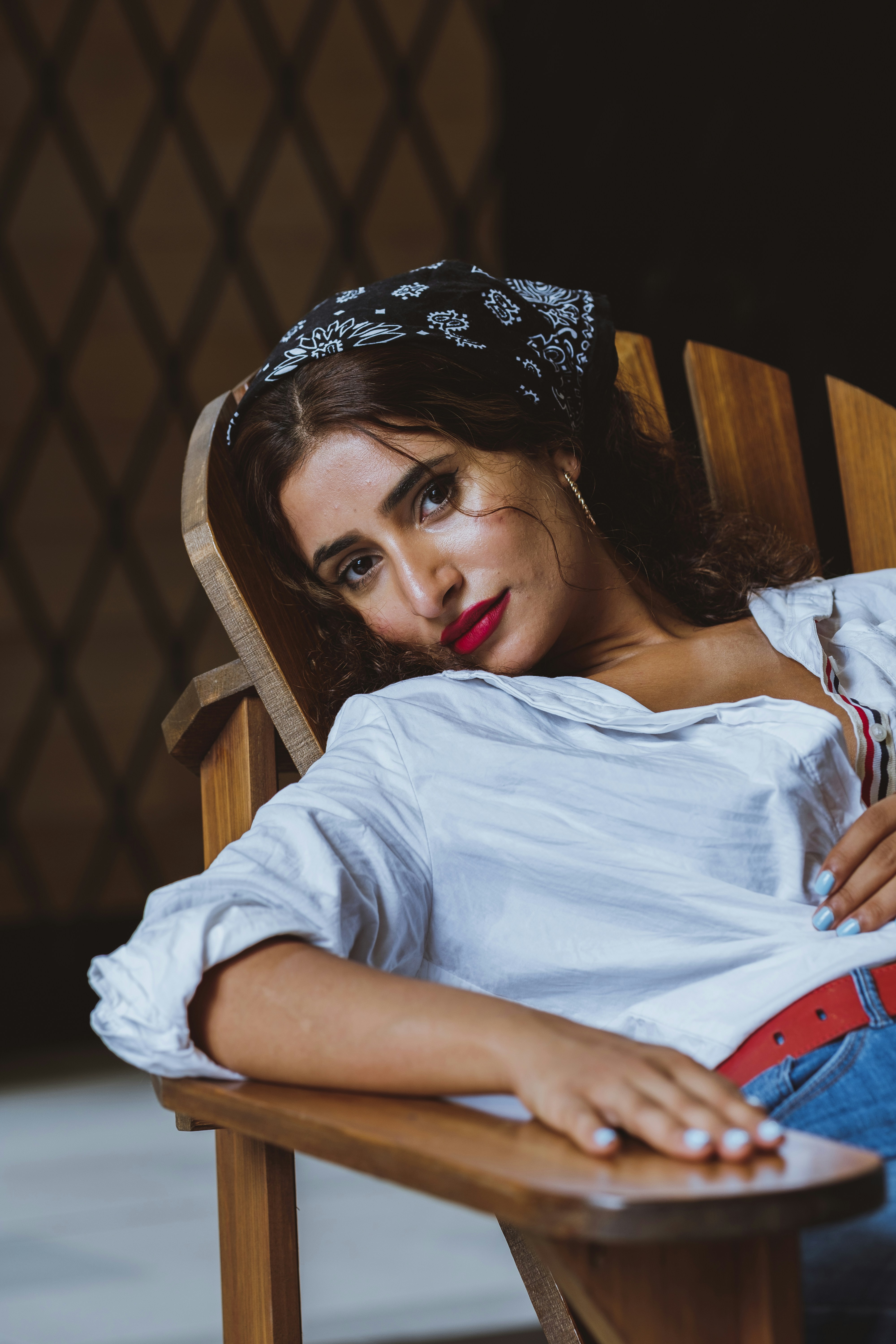 woman in white shirt sitting on brown wooden chair