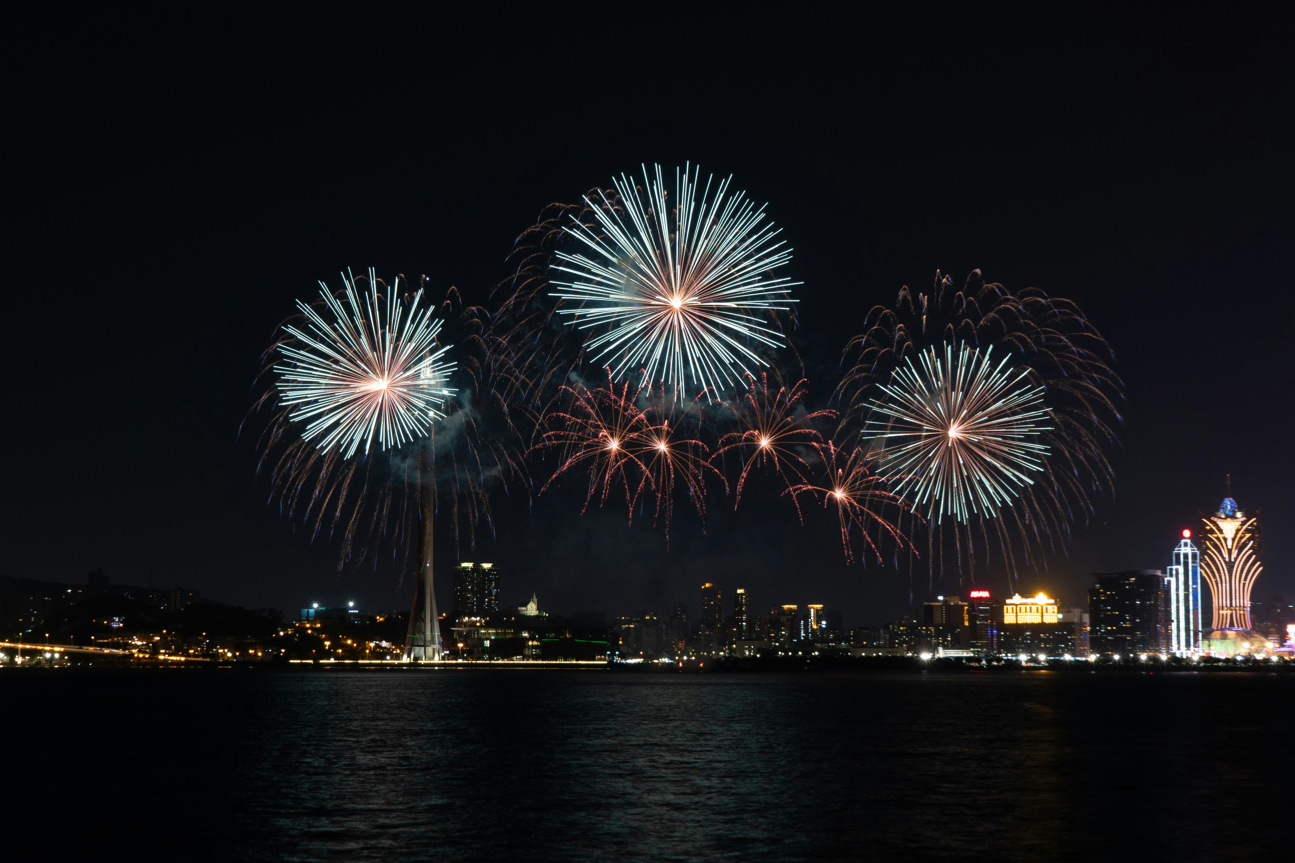 Fireworks display over city buildings during night time photo – Free ...